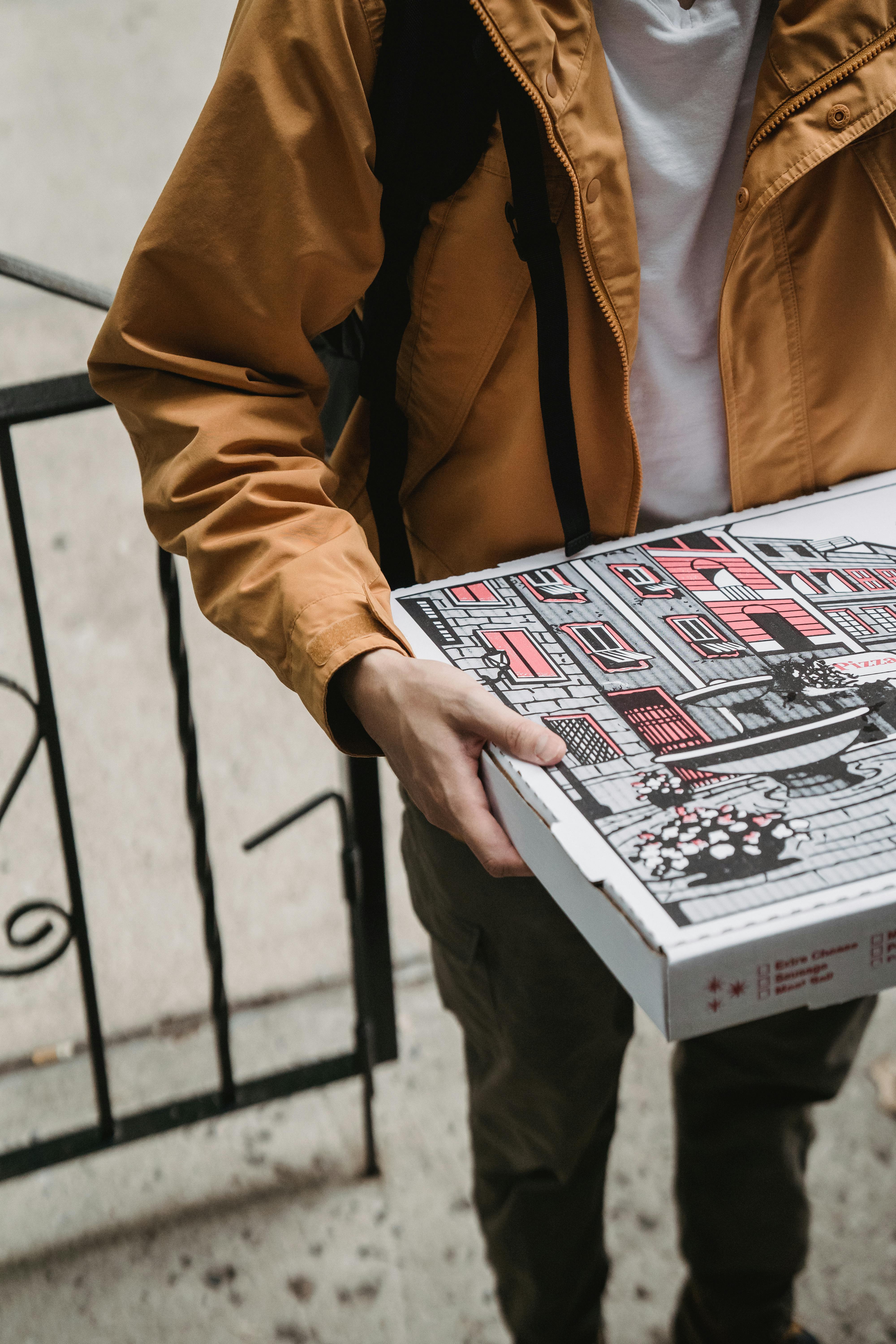 Man Carrying Pizza Box · Free Stock Photo