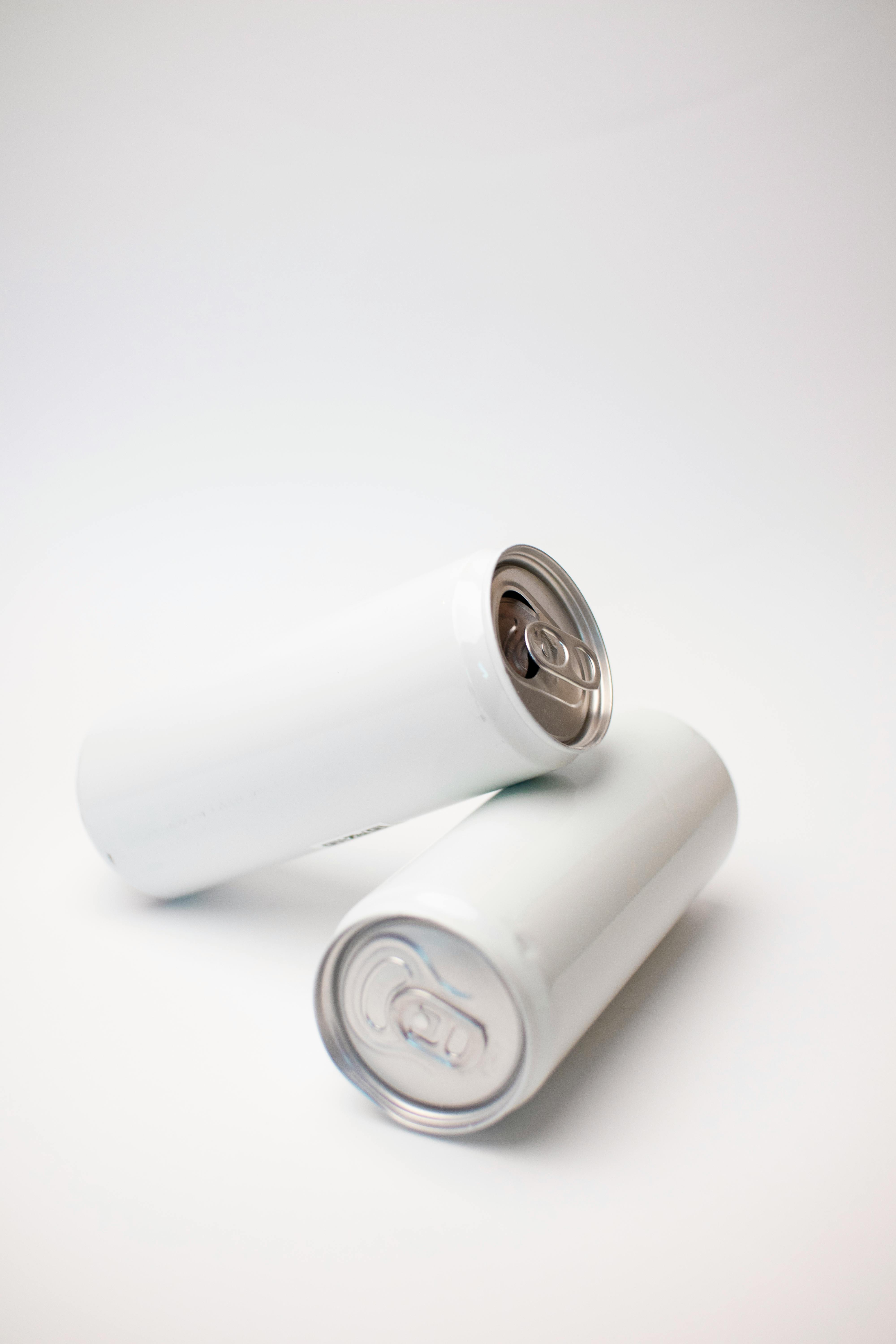 White Cans on White Surface · Free Stock Photo
