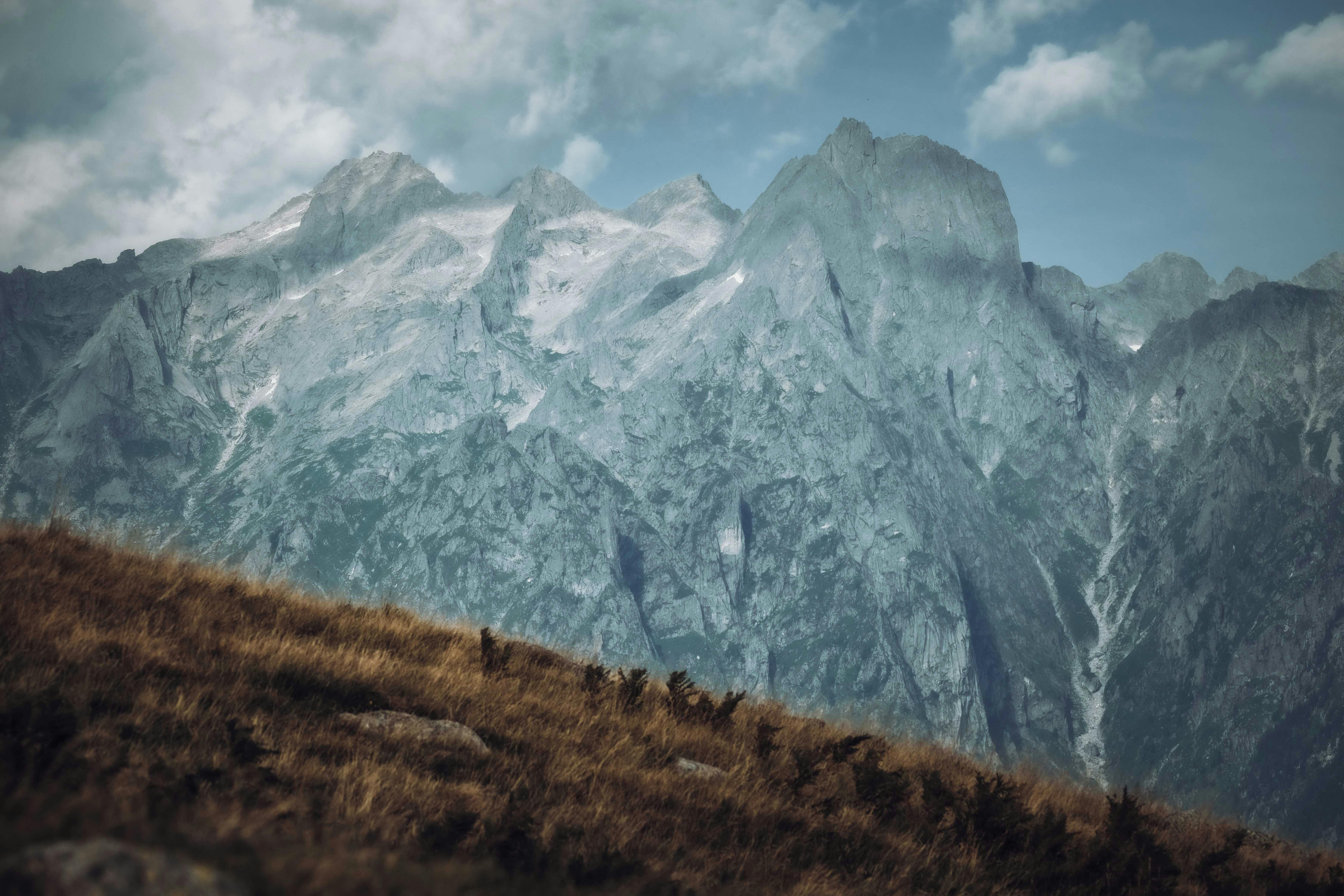 Gray Rocky Mountain Under Cloudy Sky · Free Stock Photo