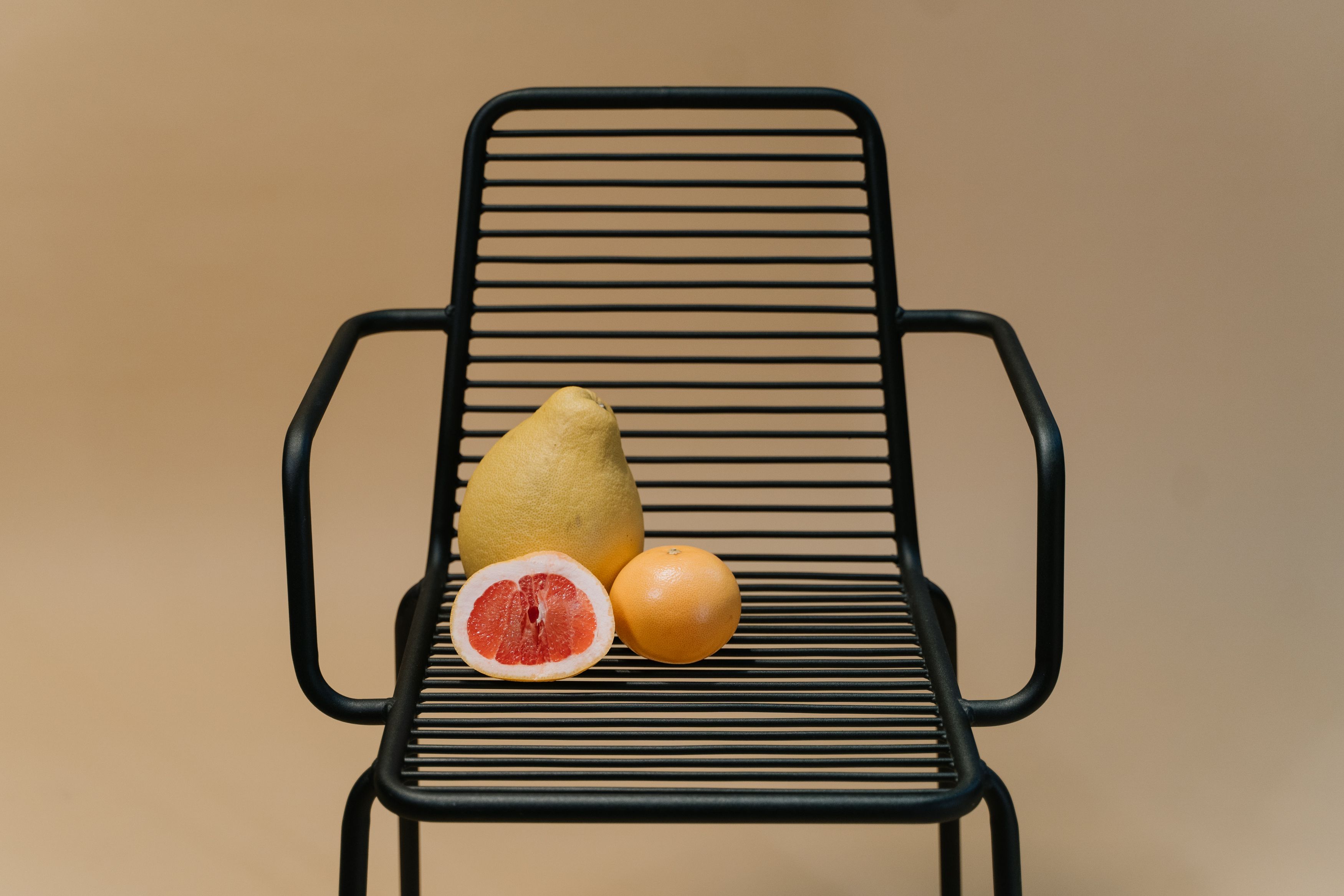 Yellow and Orange Fruits on Black Metal Chair · Free Stock Photo