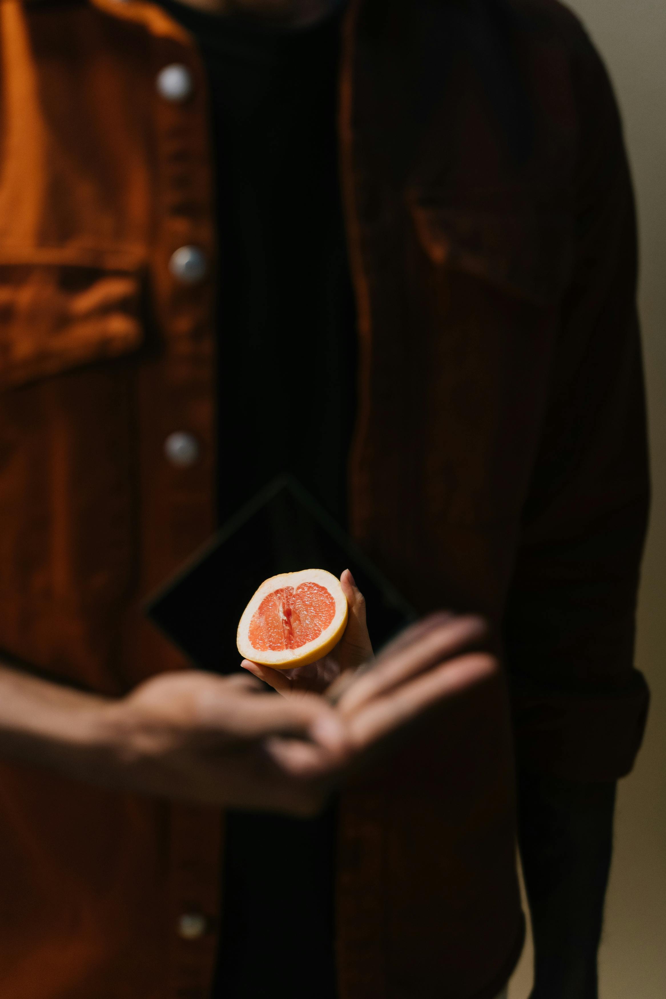 Man Holding a Grapefruit · Free Stock Photo