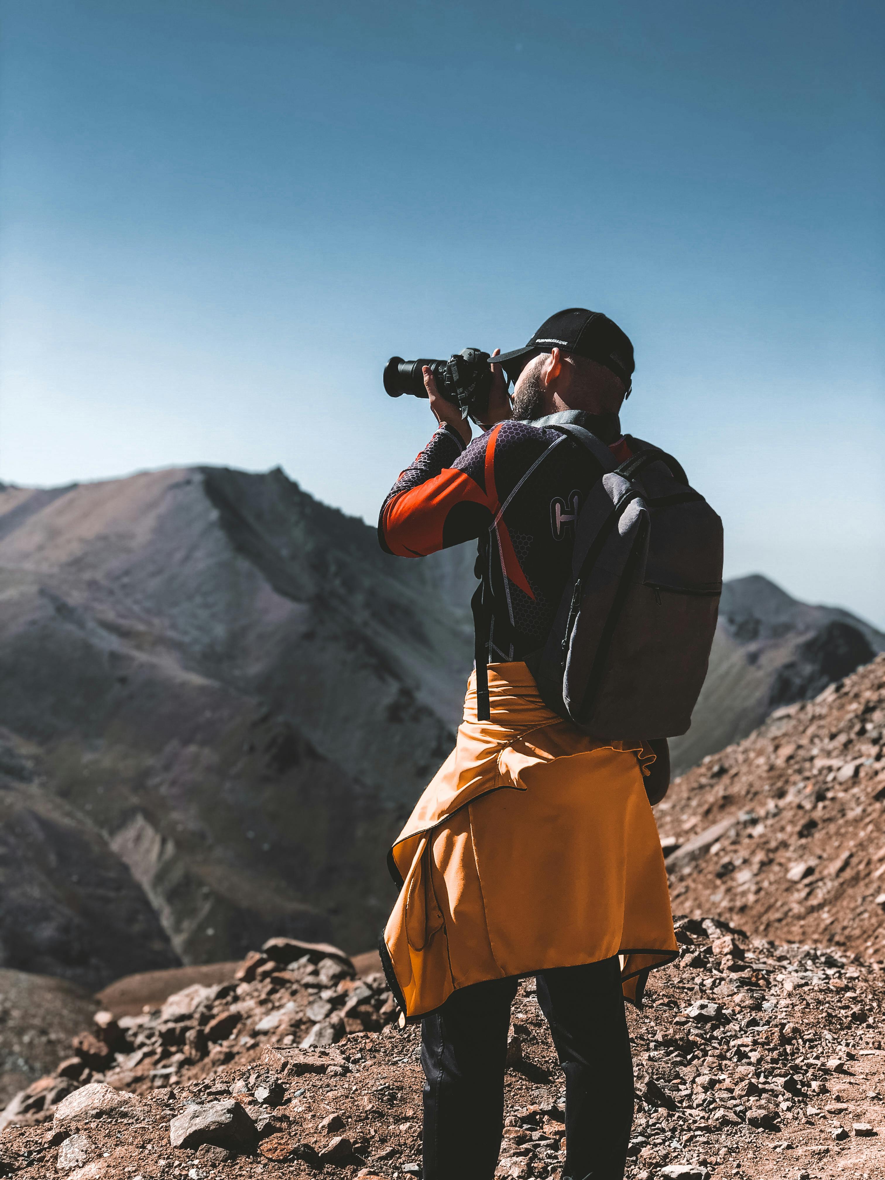 Backpacker Photographing with Camera · Free Stock Photo