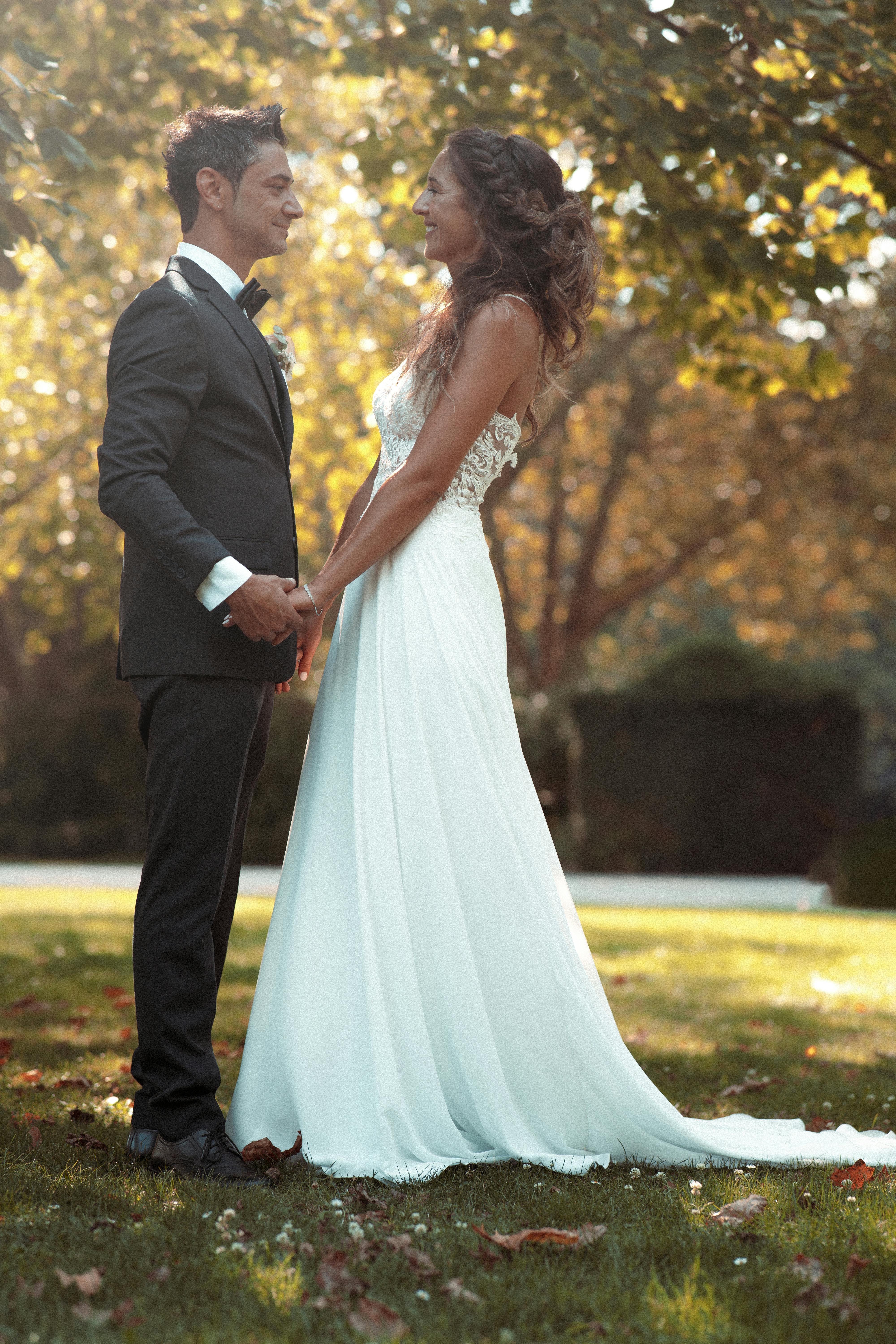 A Bride and Groom Holding Hands · Free Stock Photo