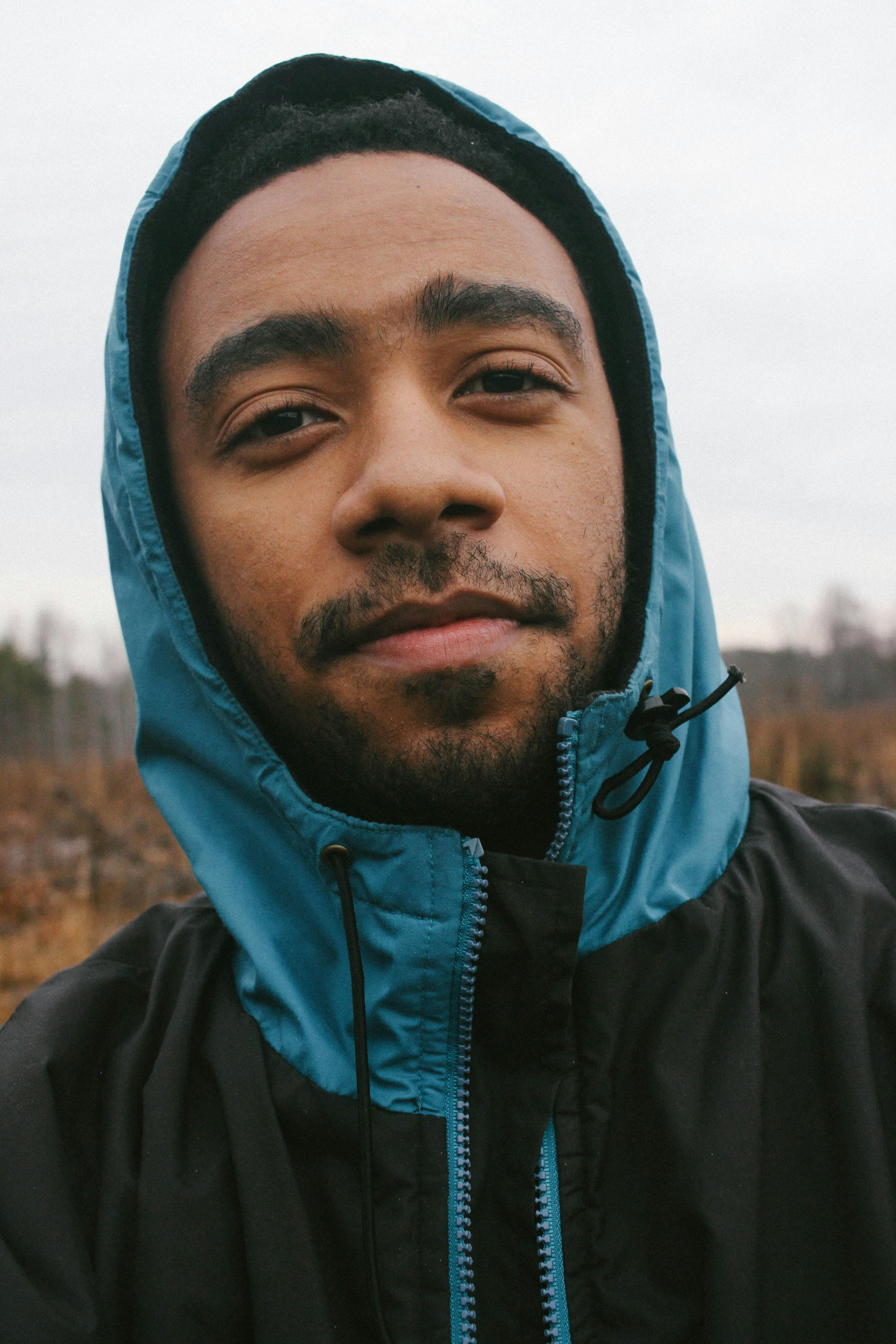 Portrait of a Man Wearing a Black and Blue Jacket · Free Stock Photo