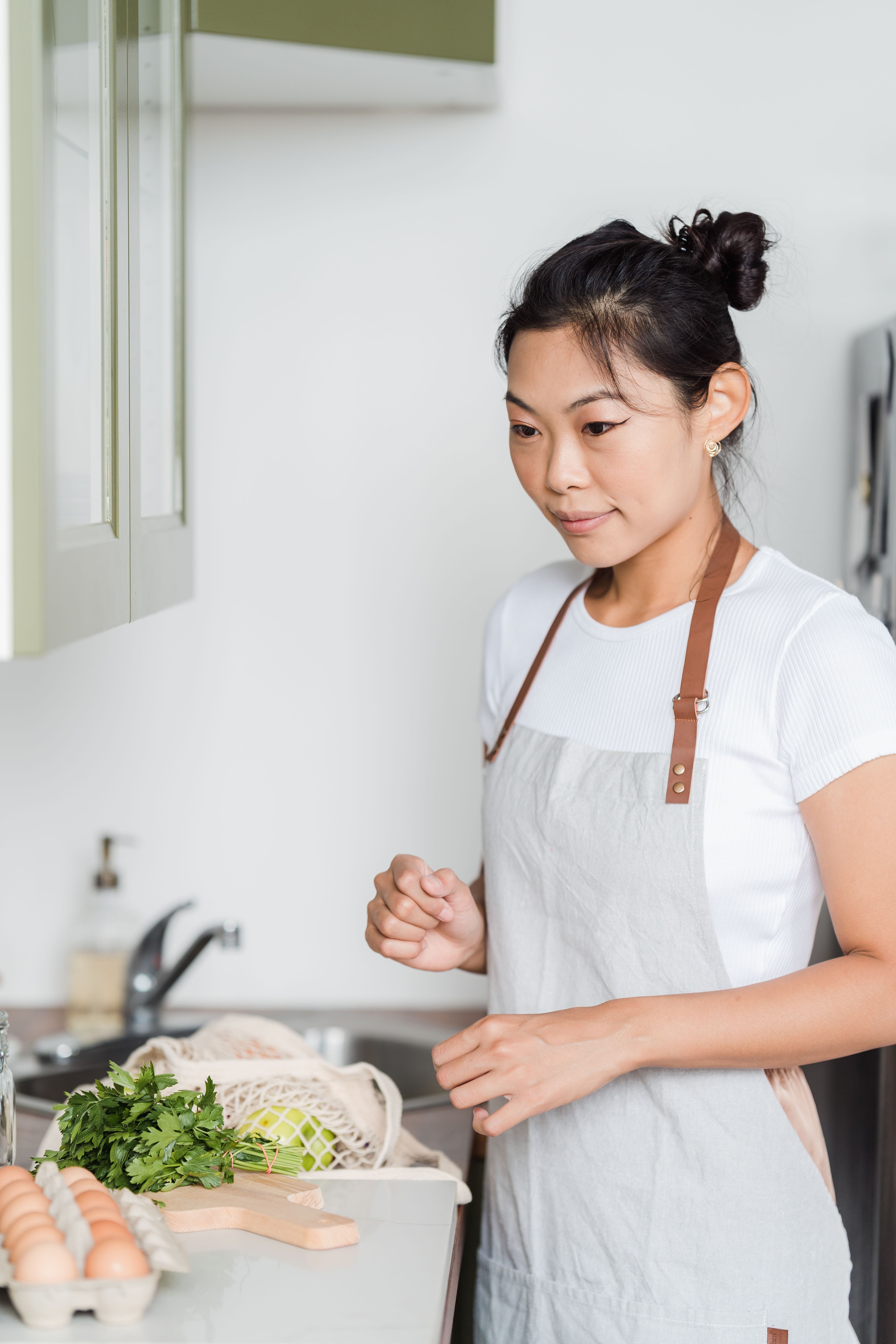 Woman in Apron Preparing to Cook · Free Stock Photo