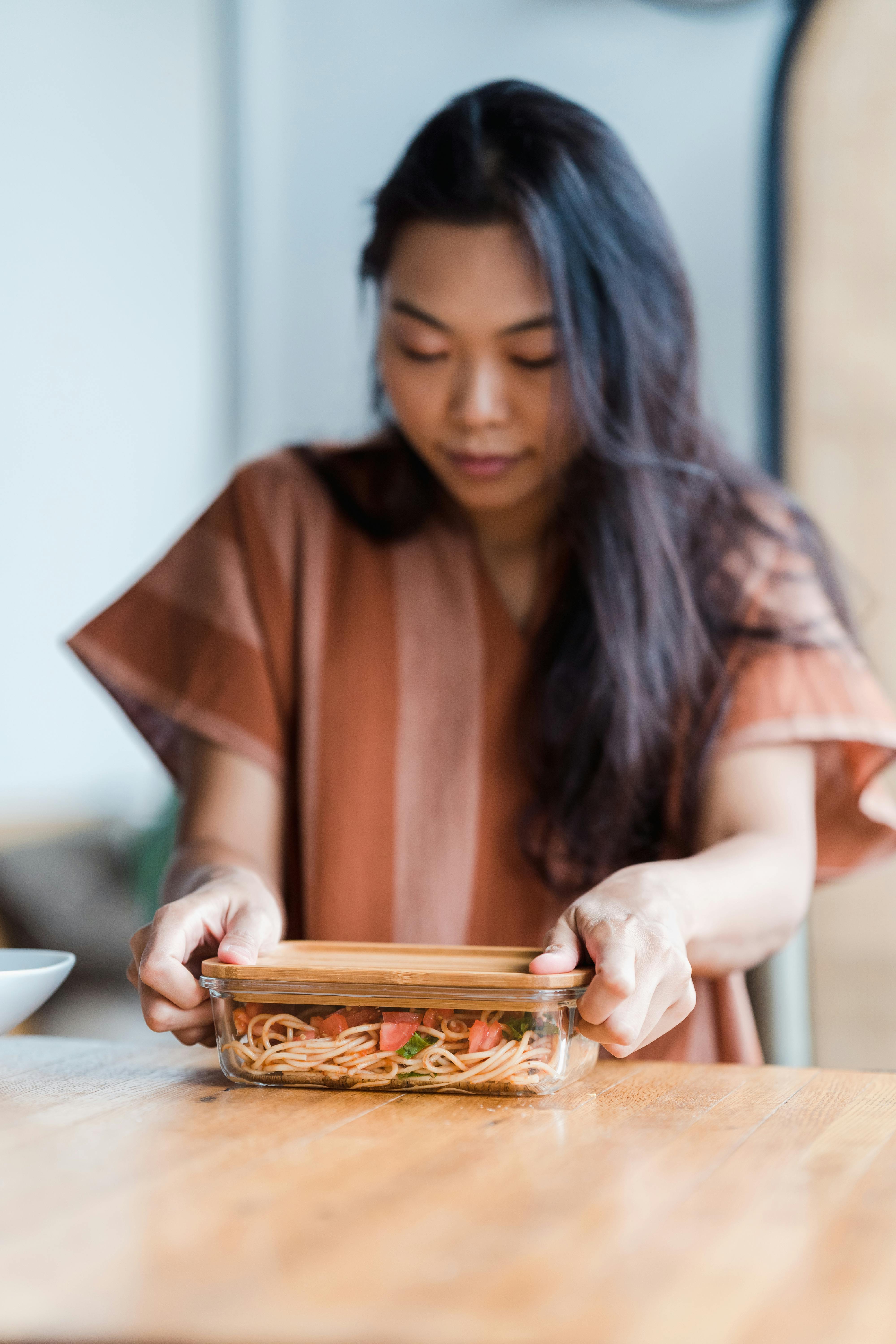 Woman Holding a Food Container · Free Stock Photo