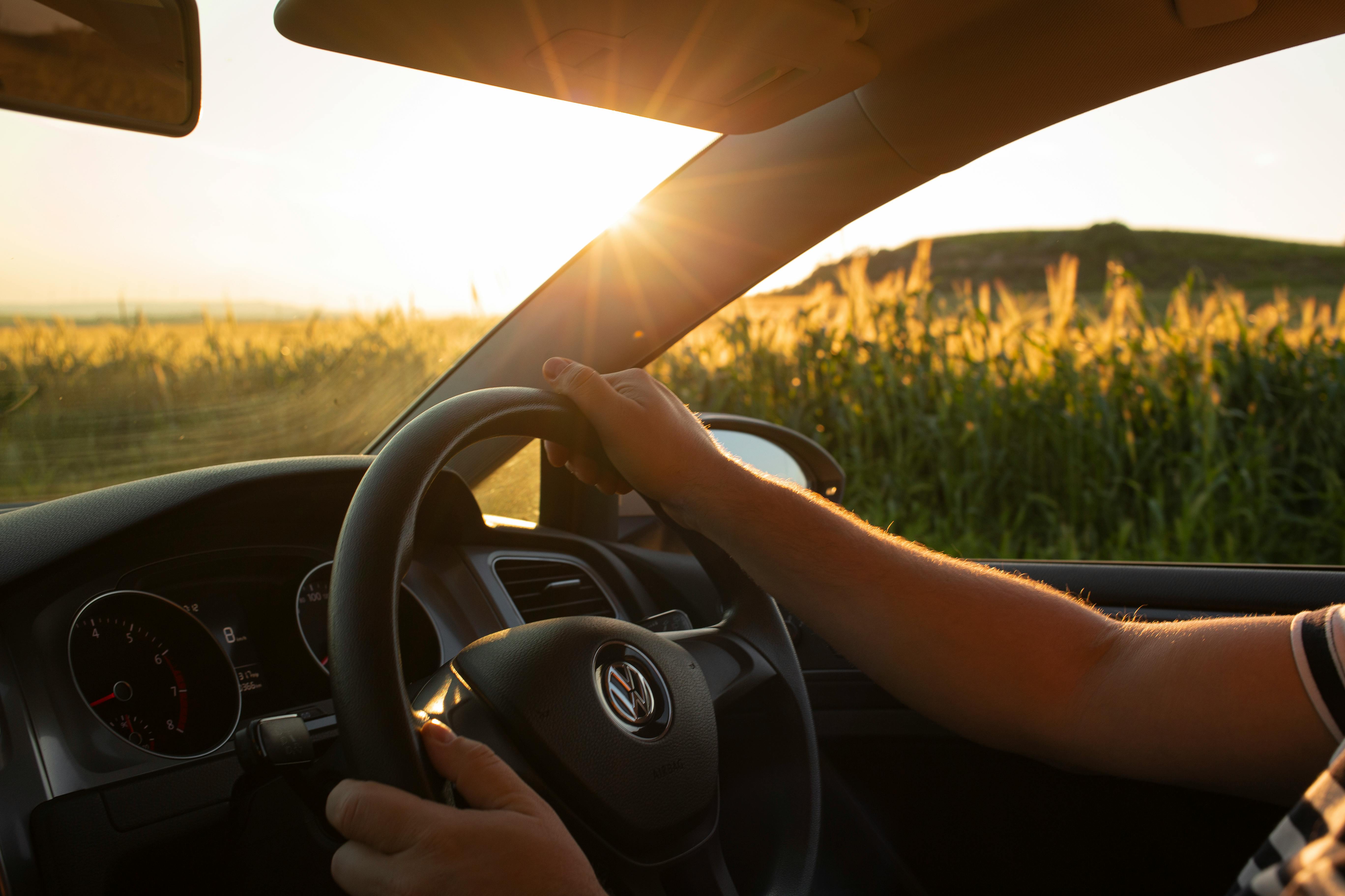 Person Driving Car during Sunset · Free Stock Photo