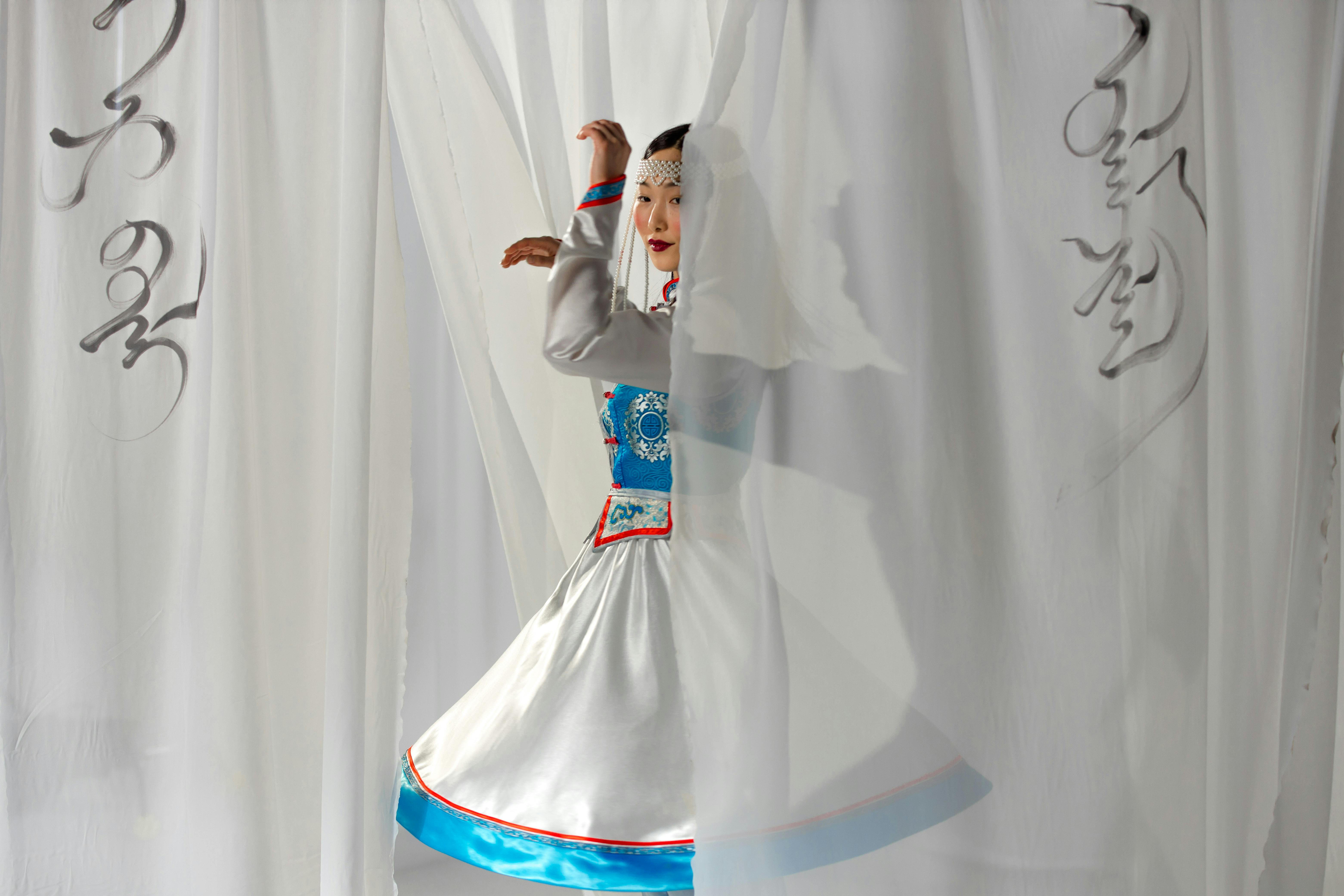 Woman in Traditional Clothing Dancing Behind White Curtain · Free Stock ...