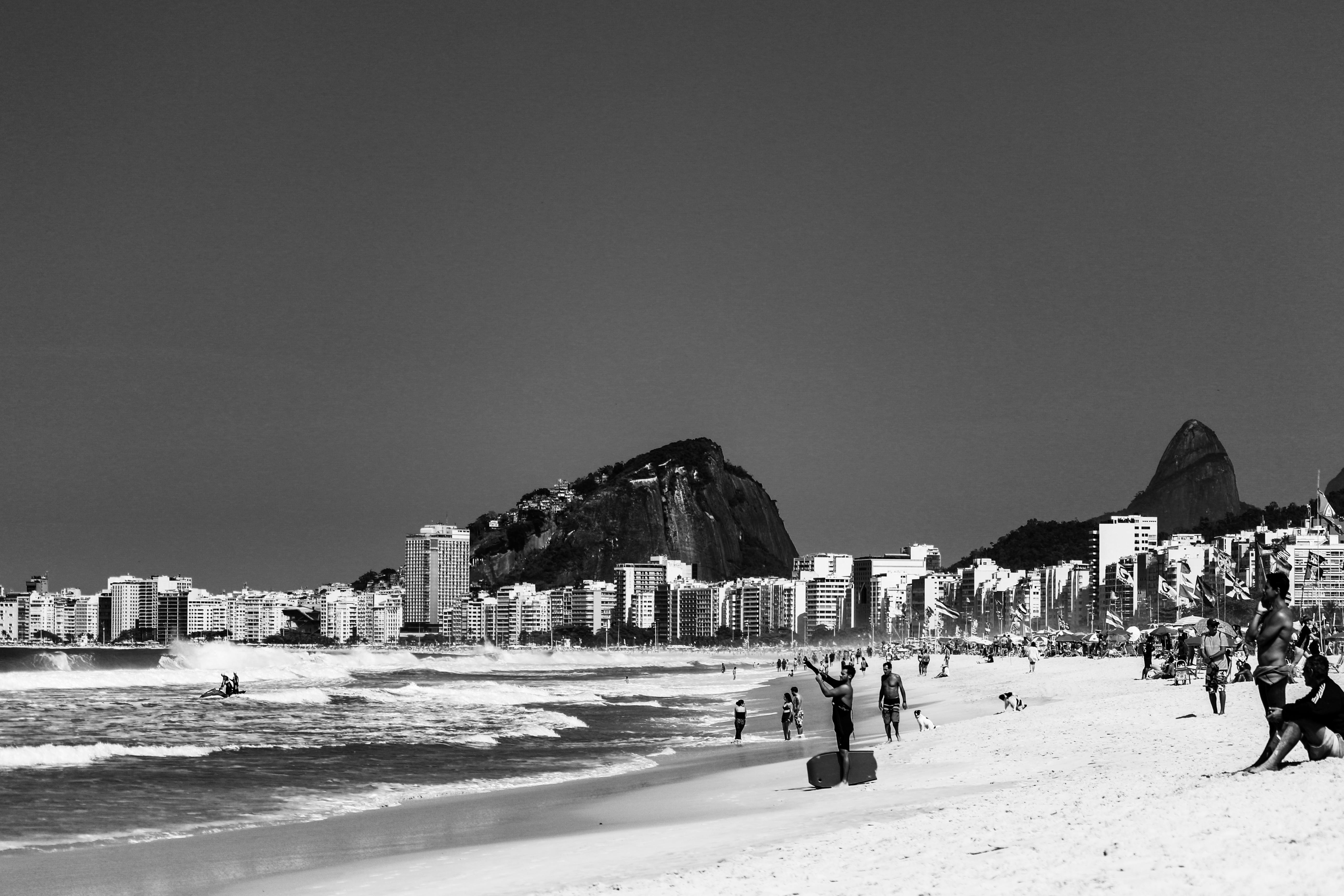 Grayscale Photography of Busy People Enjoying the Beach · Free Stock Photo