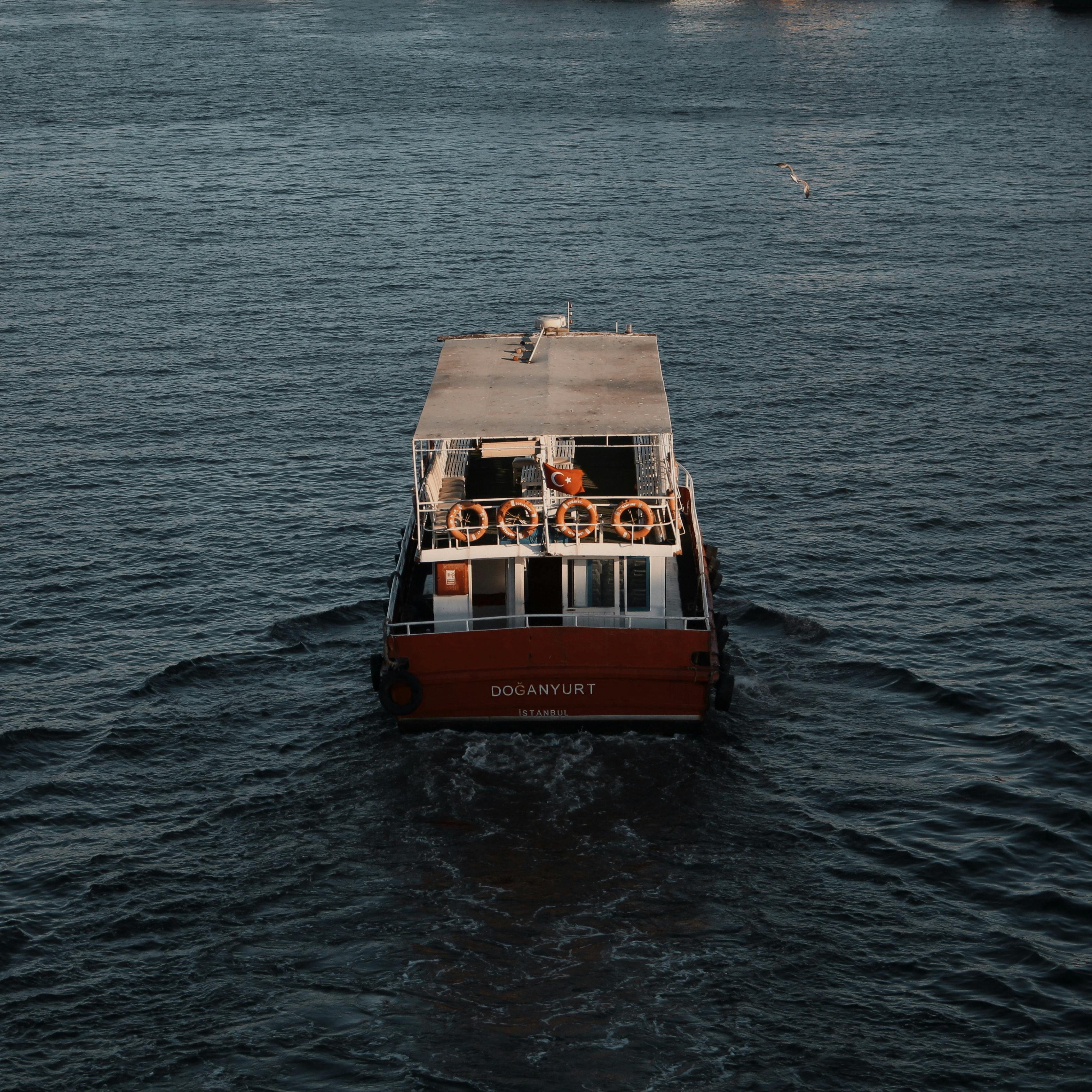 Red and White Ferry Boat on Sea · Free Stock Photo