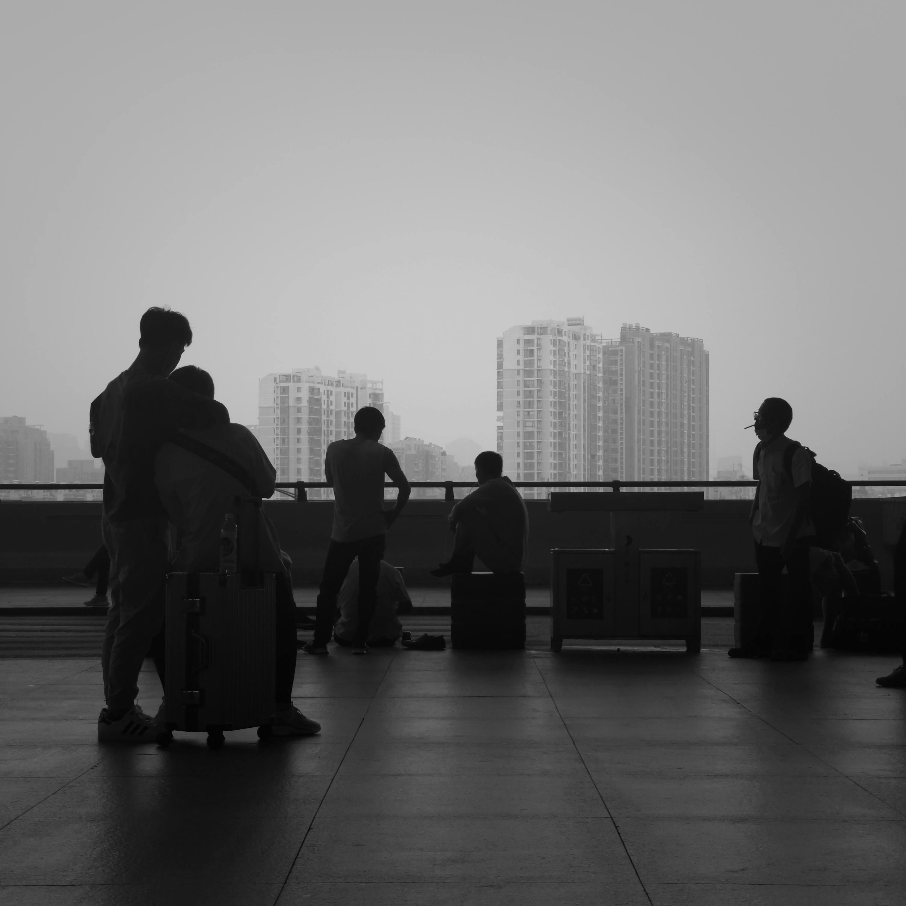 People on Terrace Looking at Buildings · Free Stock Photo