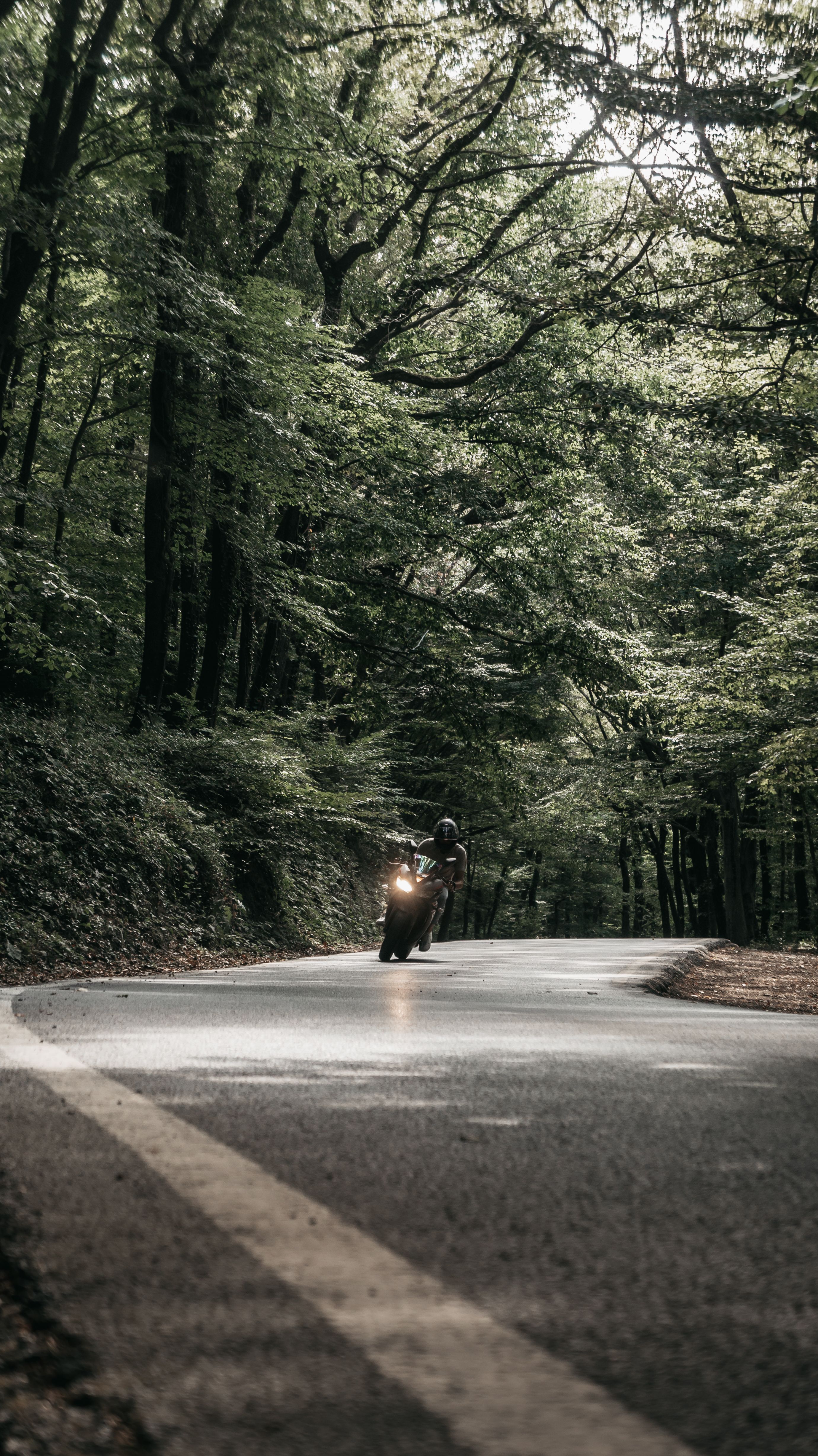 A Person Riding a Motorcycle Doing Banking · Free Stock Photo
