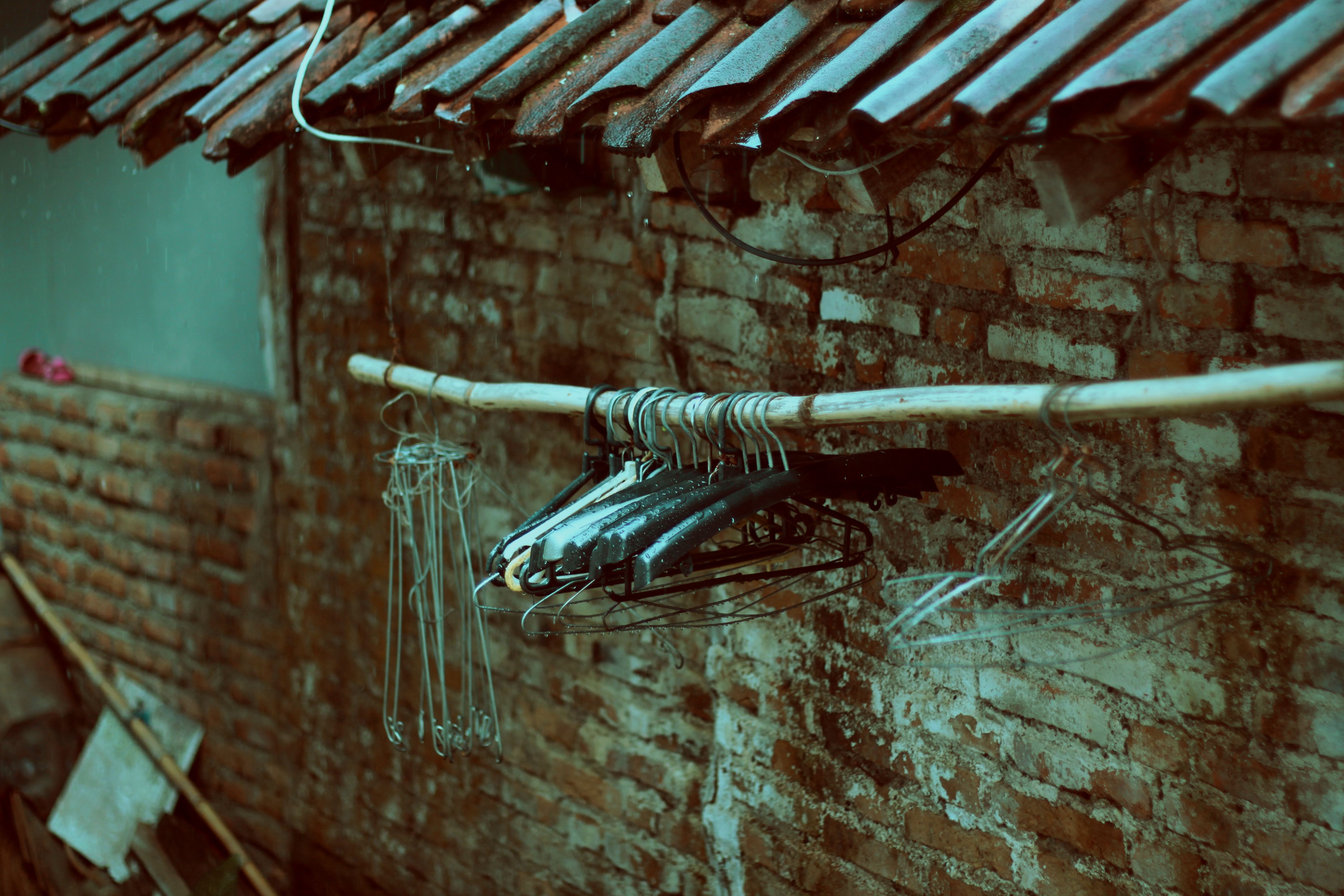 Clothes Hangers Hanging on Wooden Pole · Free Stock Photo