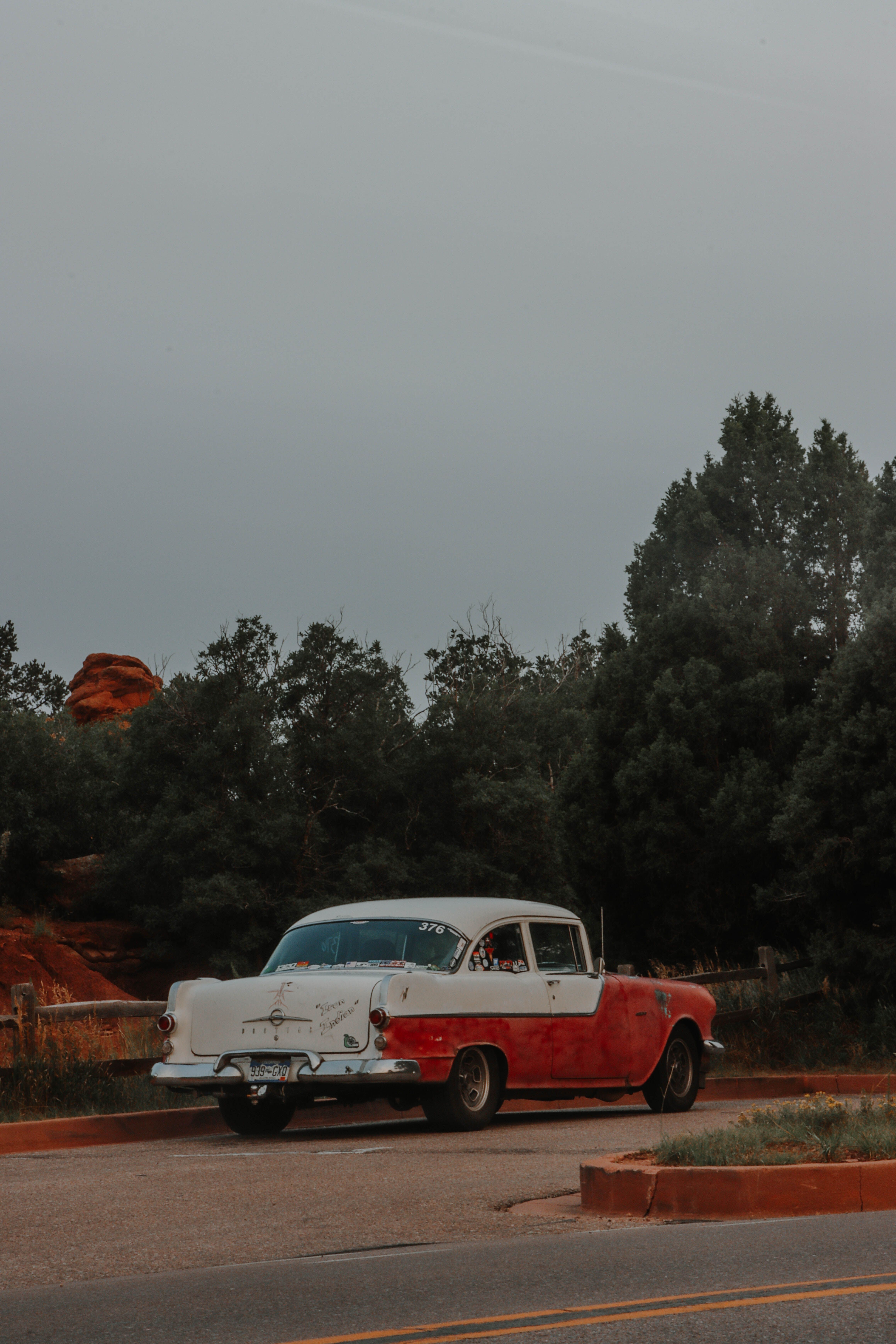 Red and White Vintage Car on the Road · Free Stock Photo