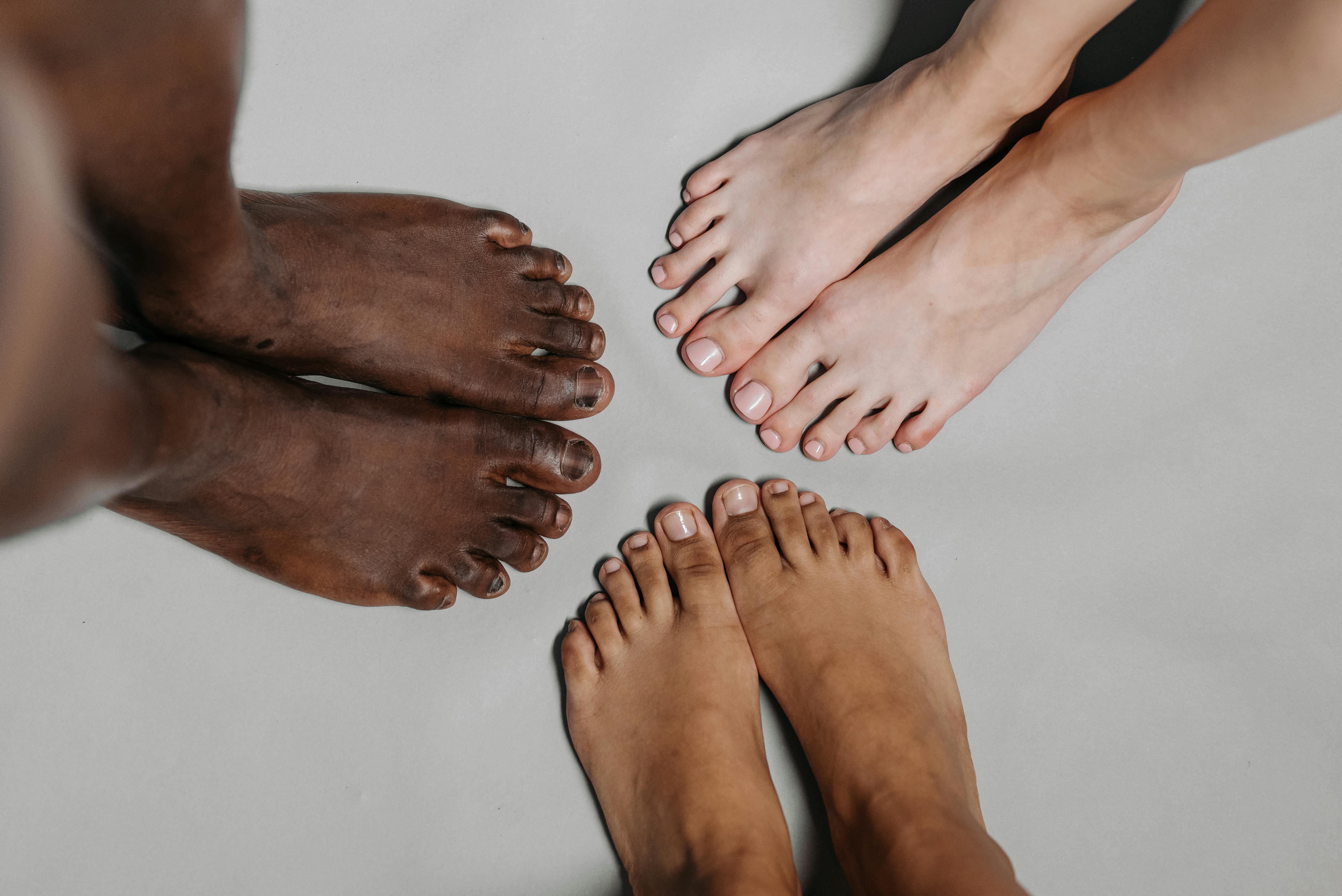 Barefooted People Standing on a White Surface · Free Stock Photo