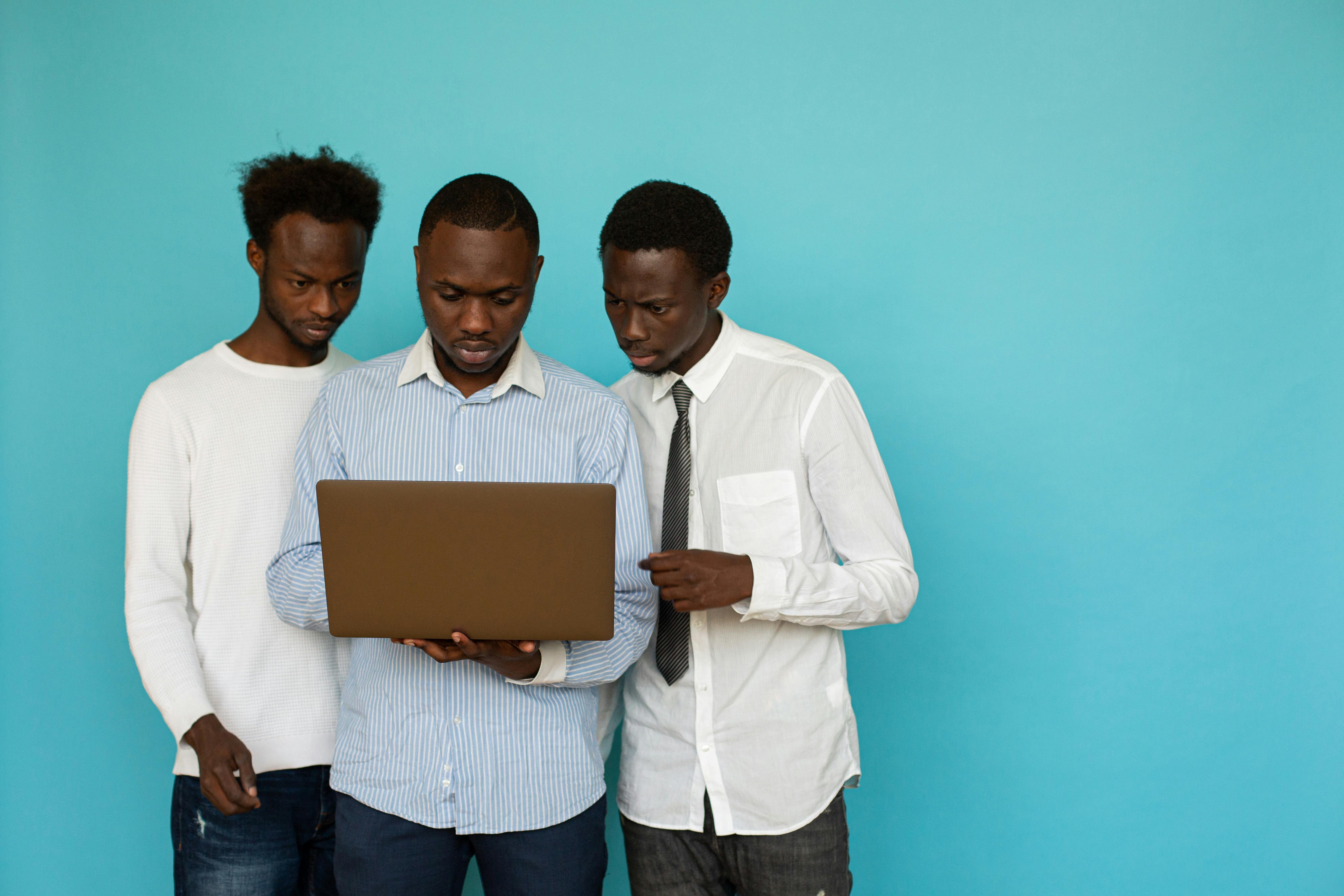Man in White Dress Shirt Holding Brown Tablet Computer · Free Stock Photo