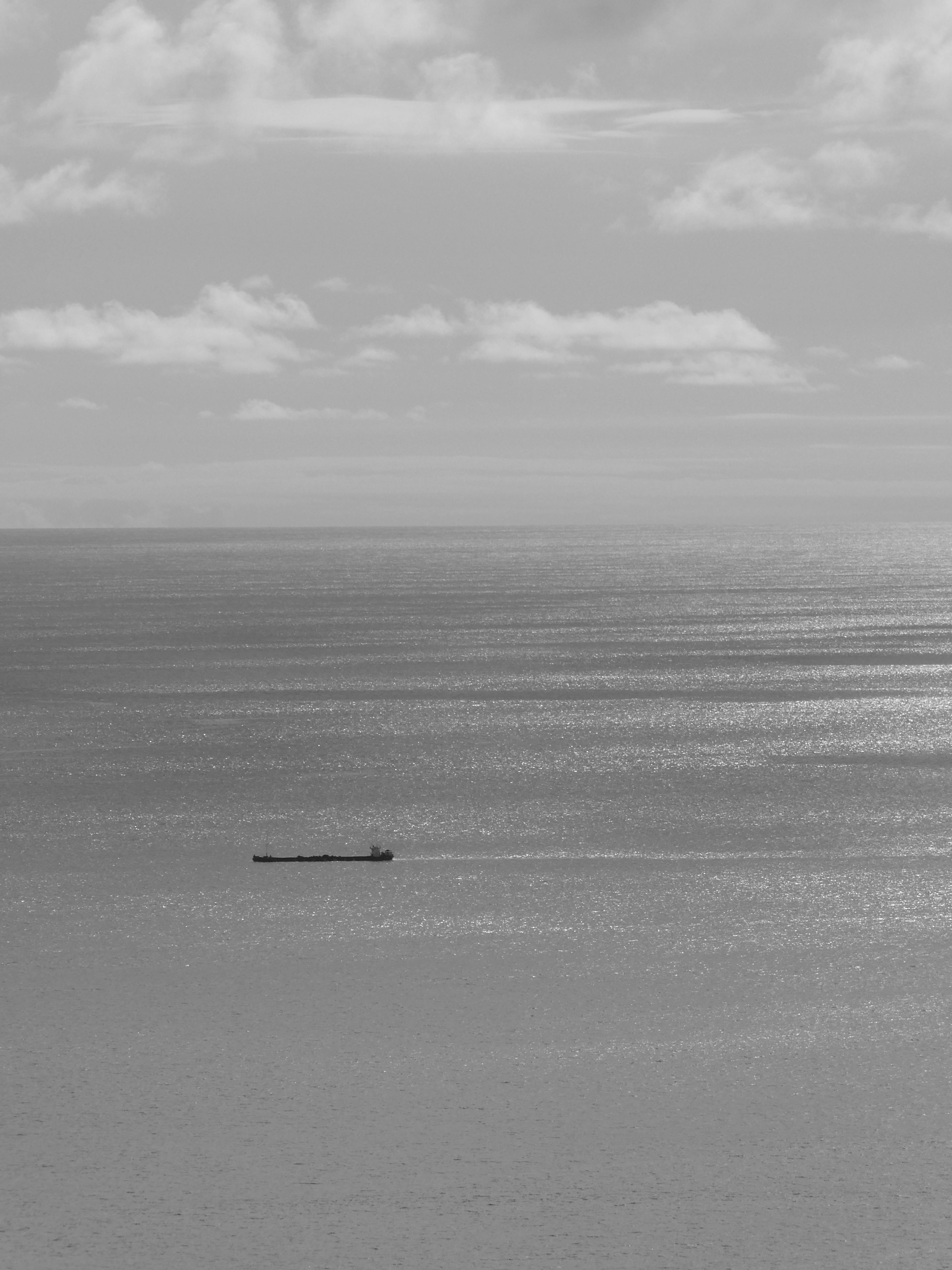 Grayscale Photo of a Watercraft at Sea · Free Stock Photo