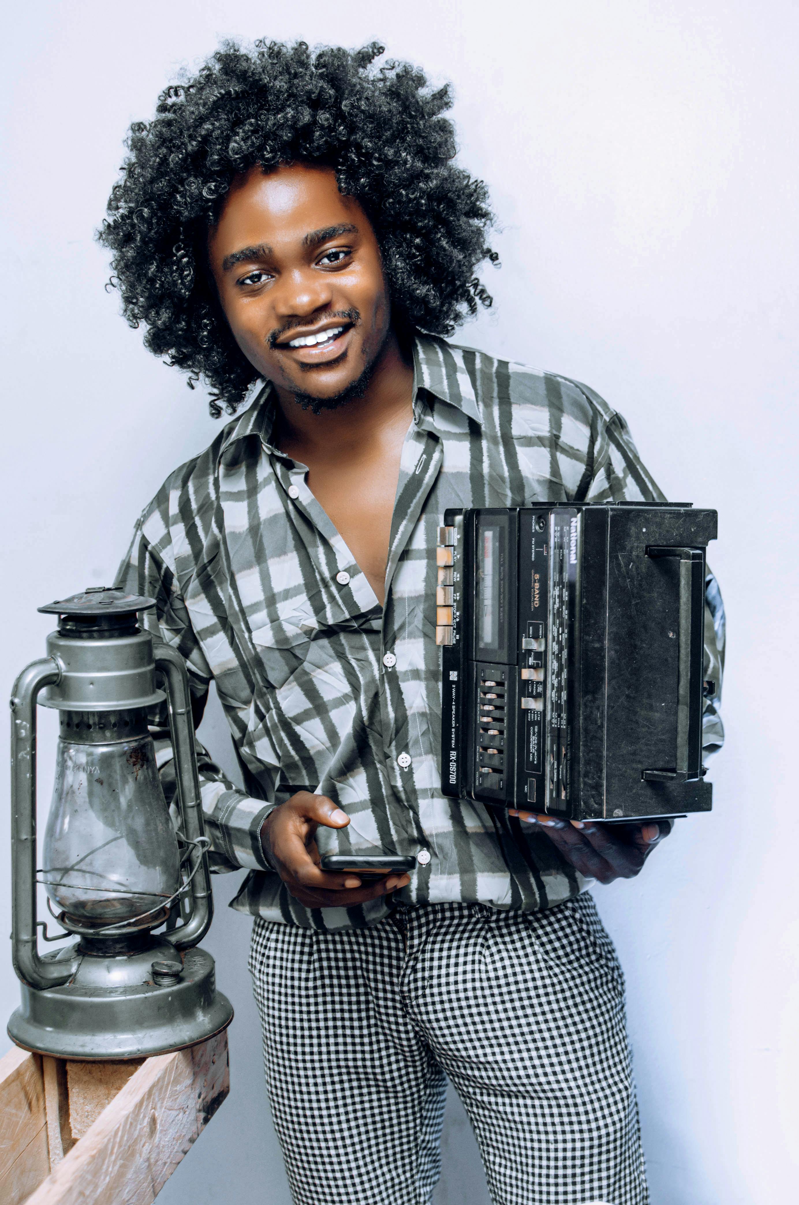 Man Carrying a Vintage Cassette Player · Free Stock Photo