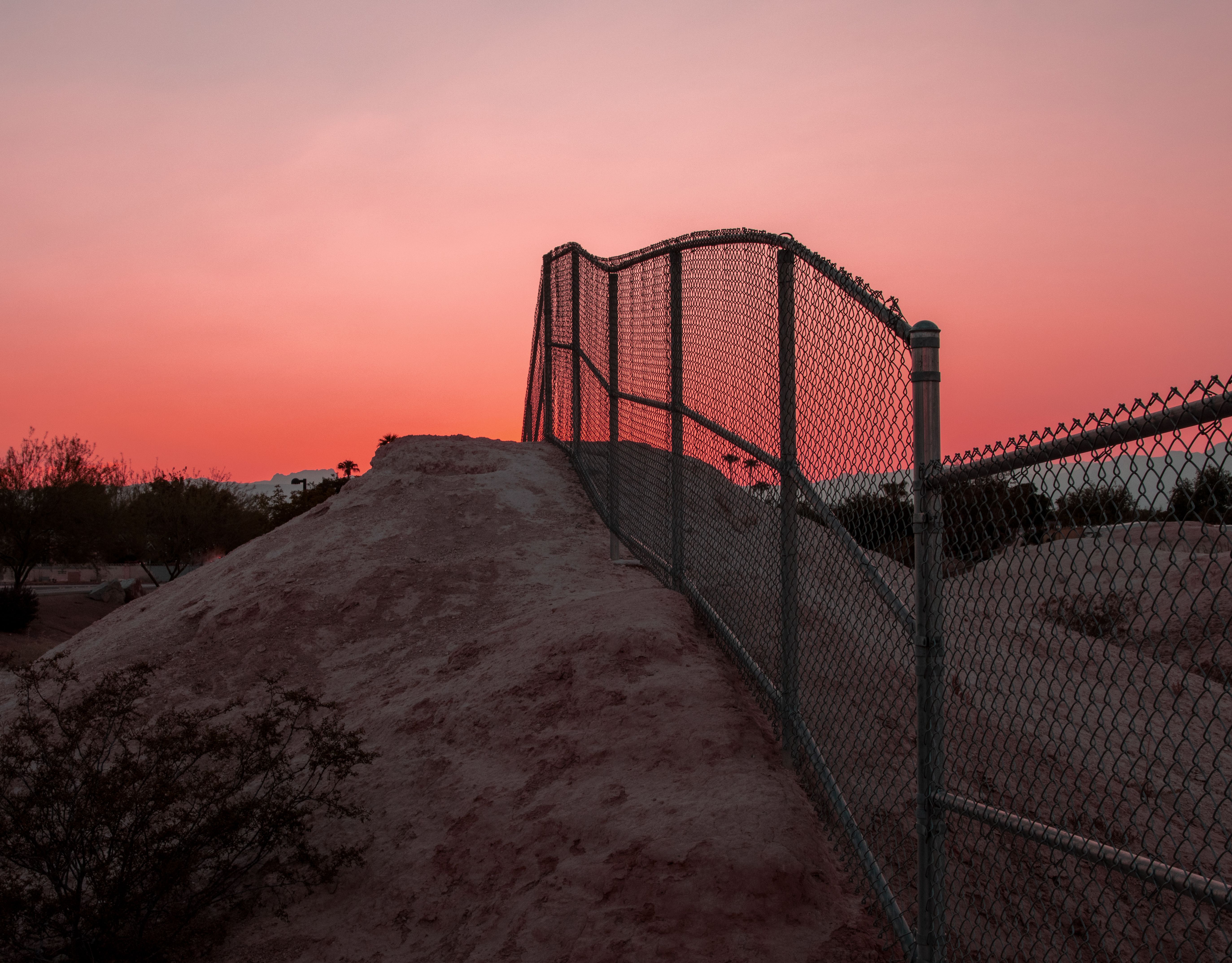 Metal Fence on Hill Under Sunset · Free Stock Photo