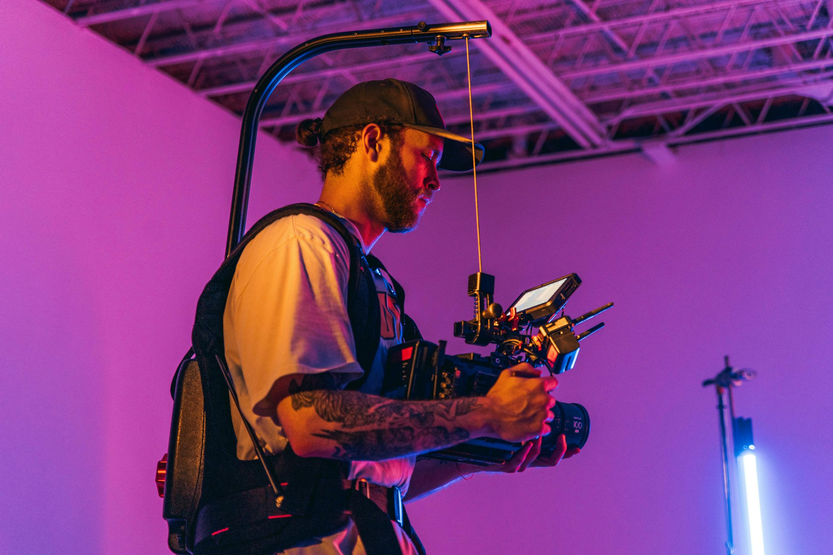 Side View of a Cameraman Recording Using a Camera · Free Stock Photo