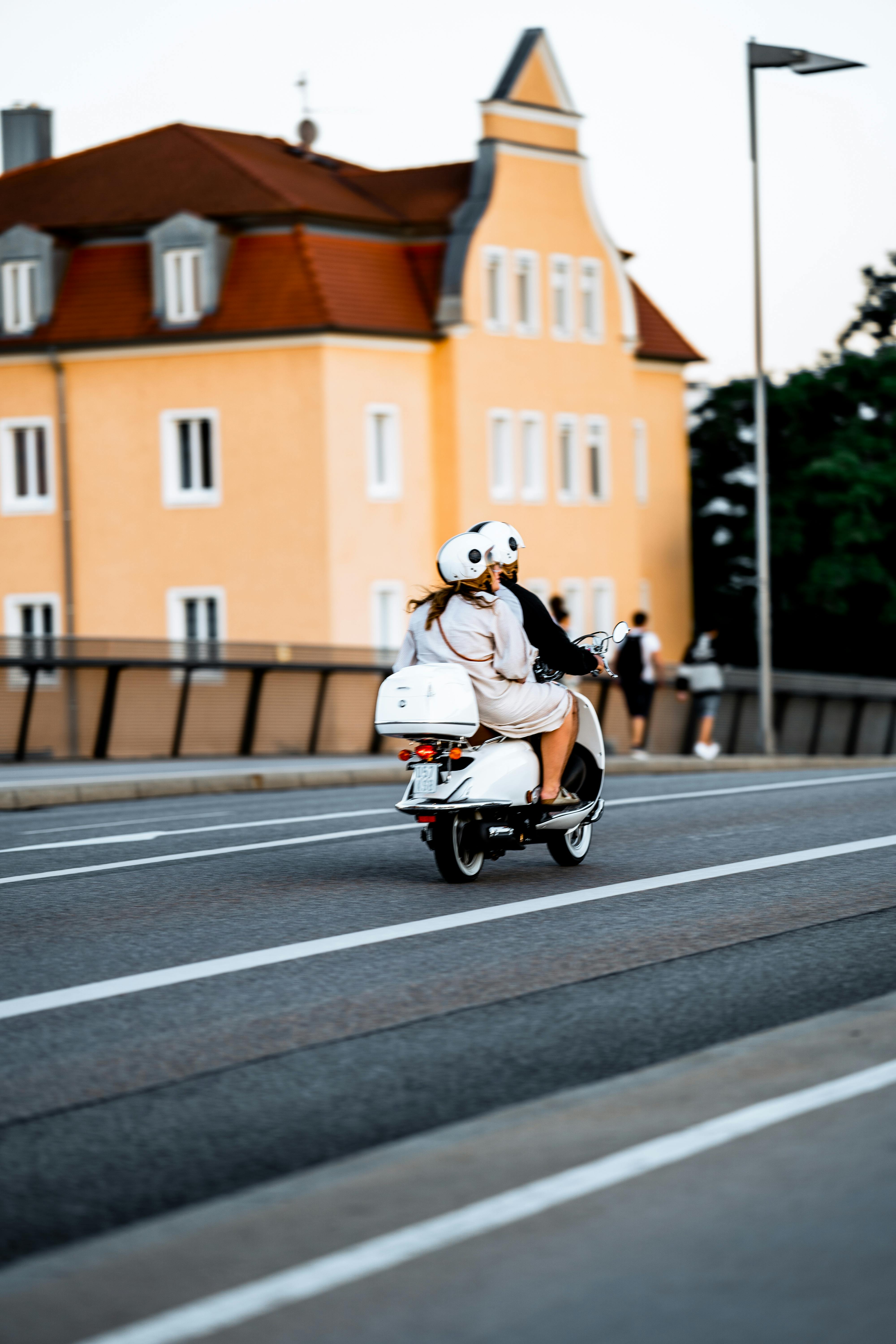 Photo of a Boy in an Orange Shirt Riding a Motorcycle · Free Stock Photo