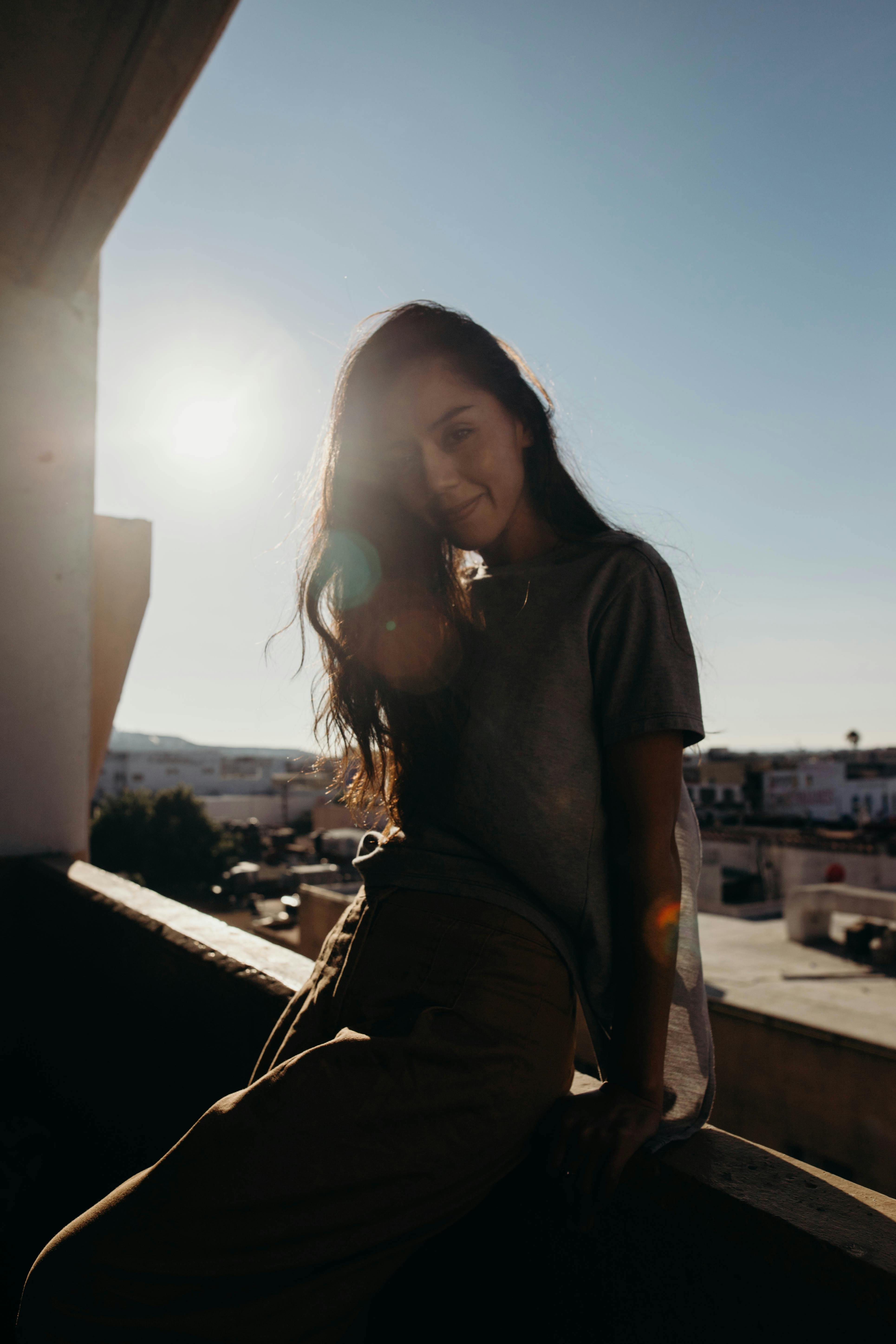 A Woman in Red Dress Dancing on a Ledge · Free Stock Photo