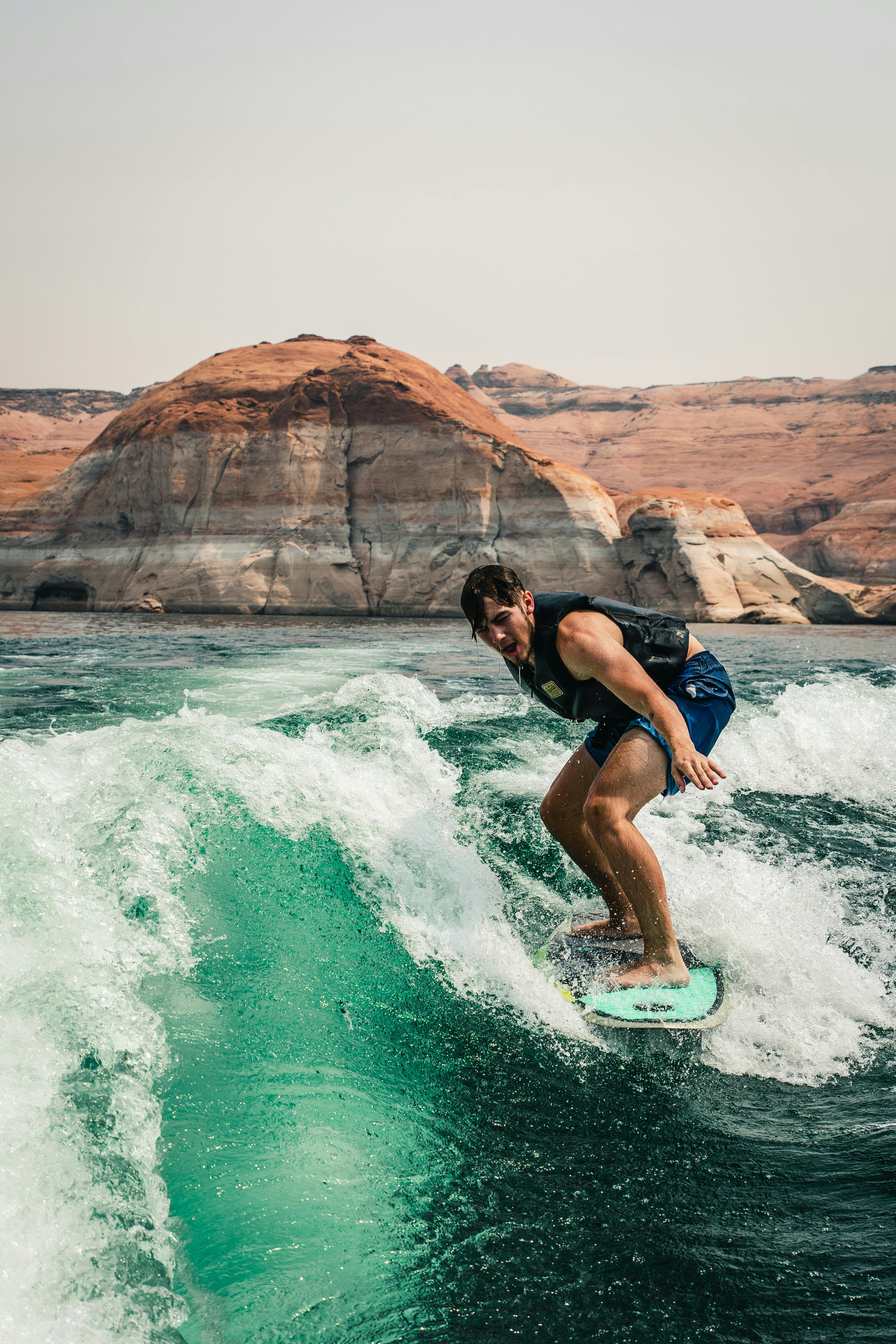Man Surfboarding Near the Coast on the Background of a Cliff · Free ...
