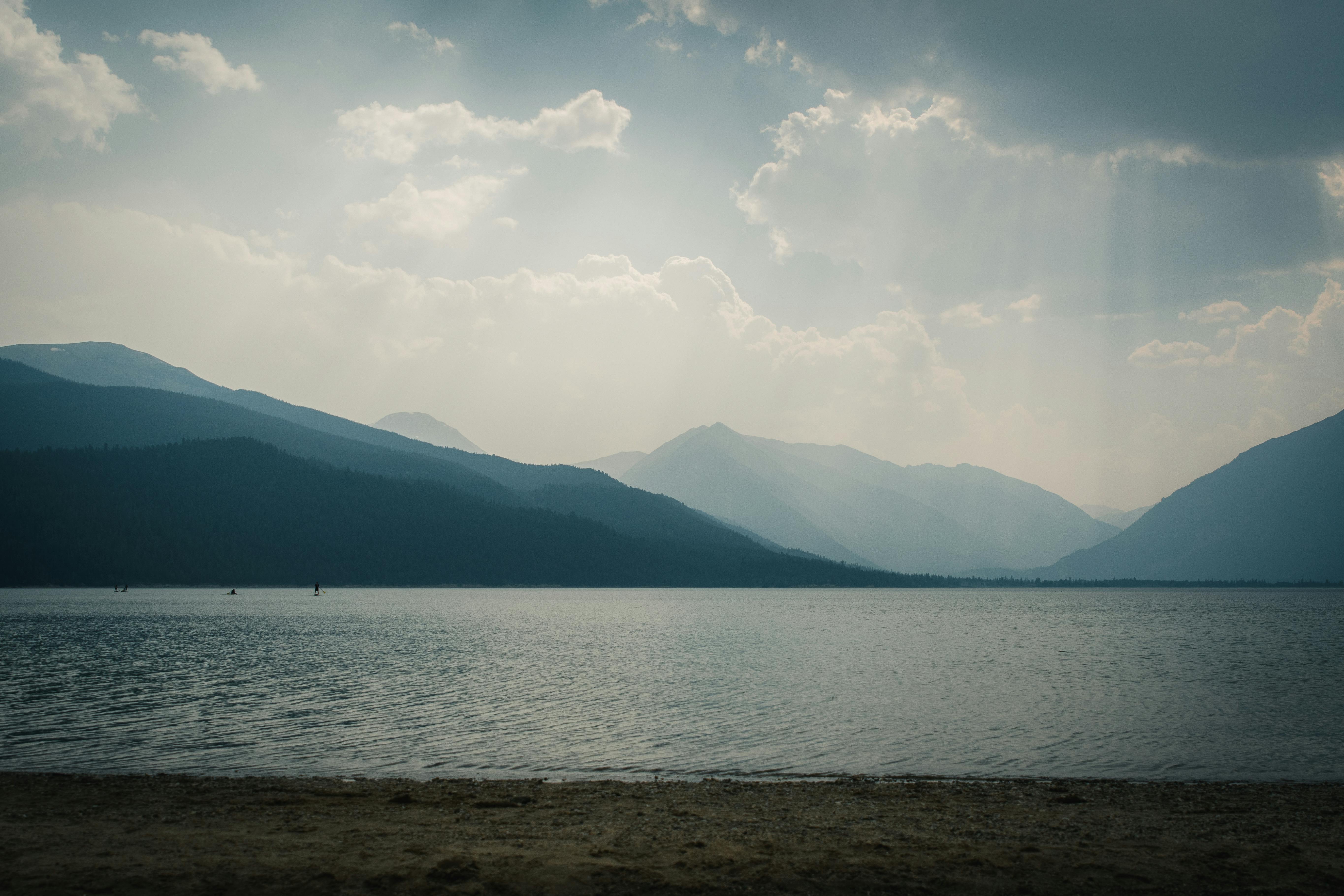 Mountains near Calm Sea on Sunset · Free Stock Photo