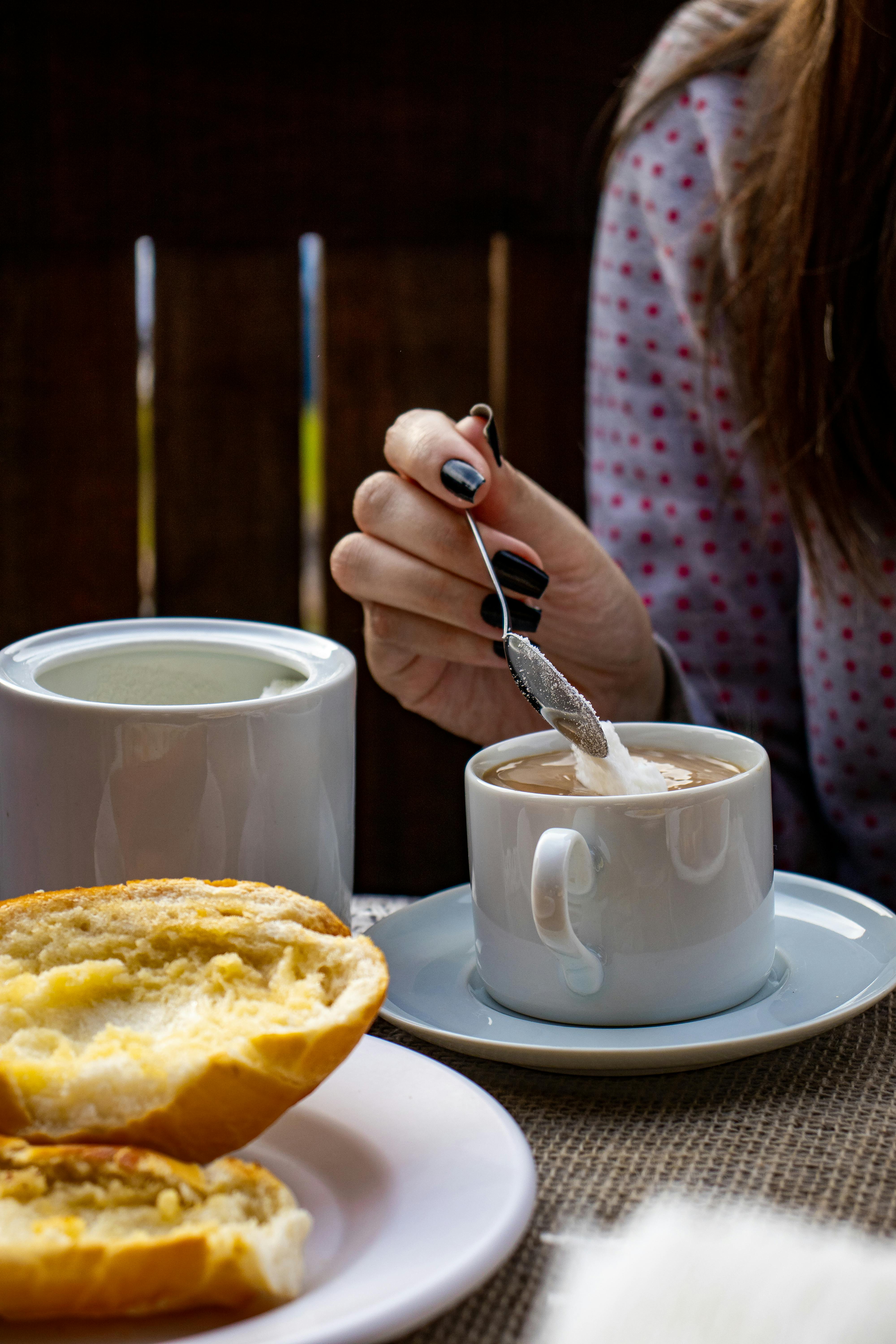 A Person Putting Sugar on Coffee · Free Stock Photo