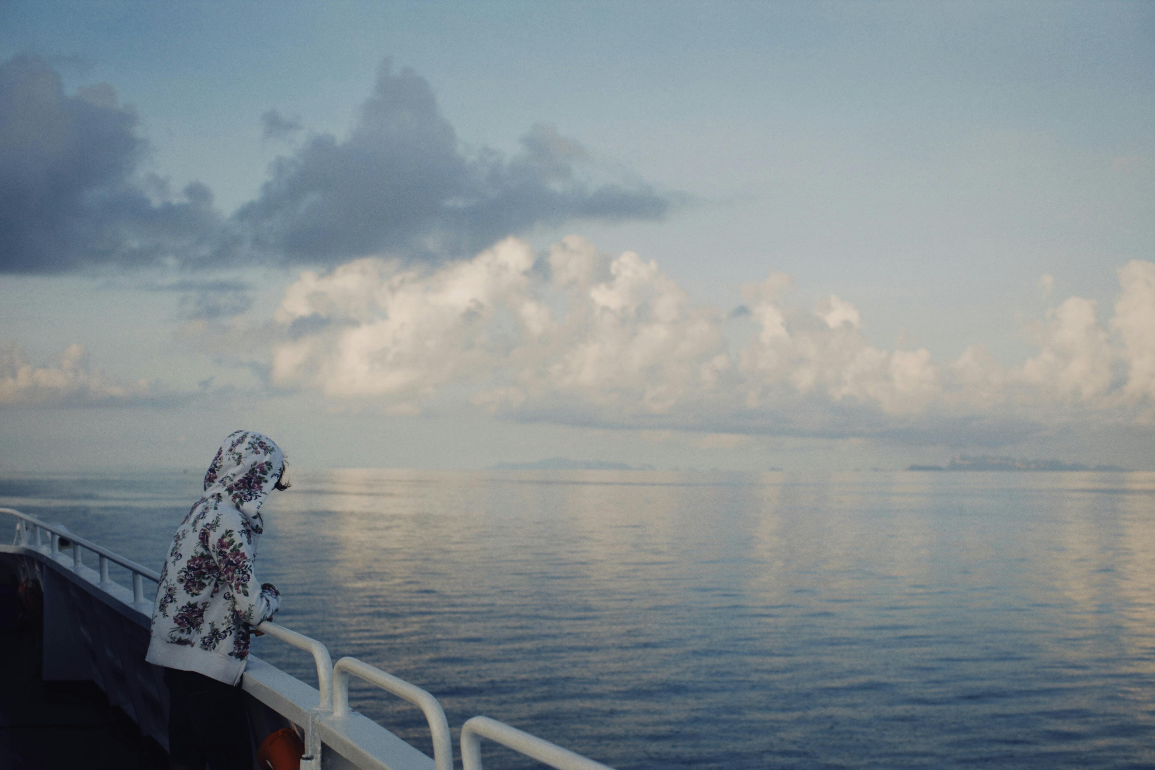 A Person Riding on a Boat on the Sea · Free Stock Photo