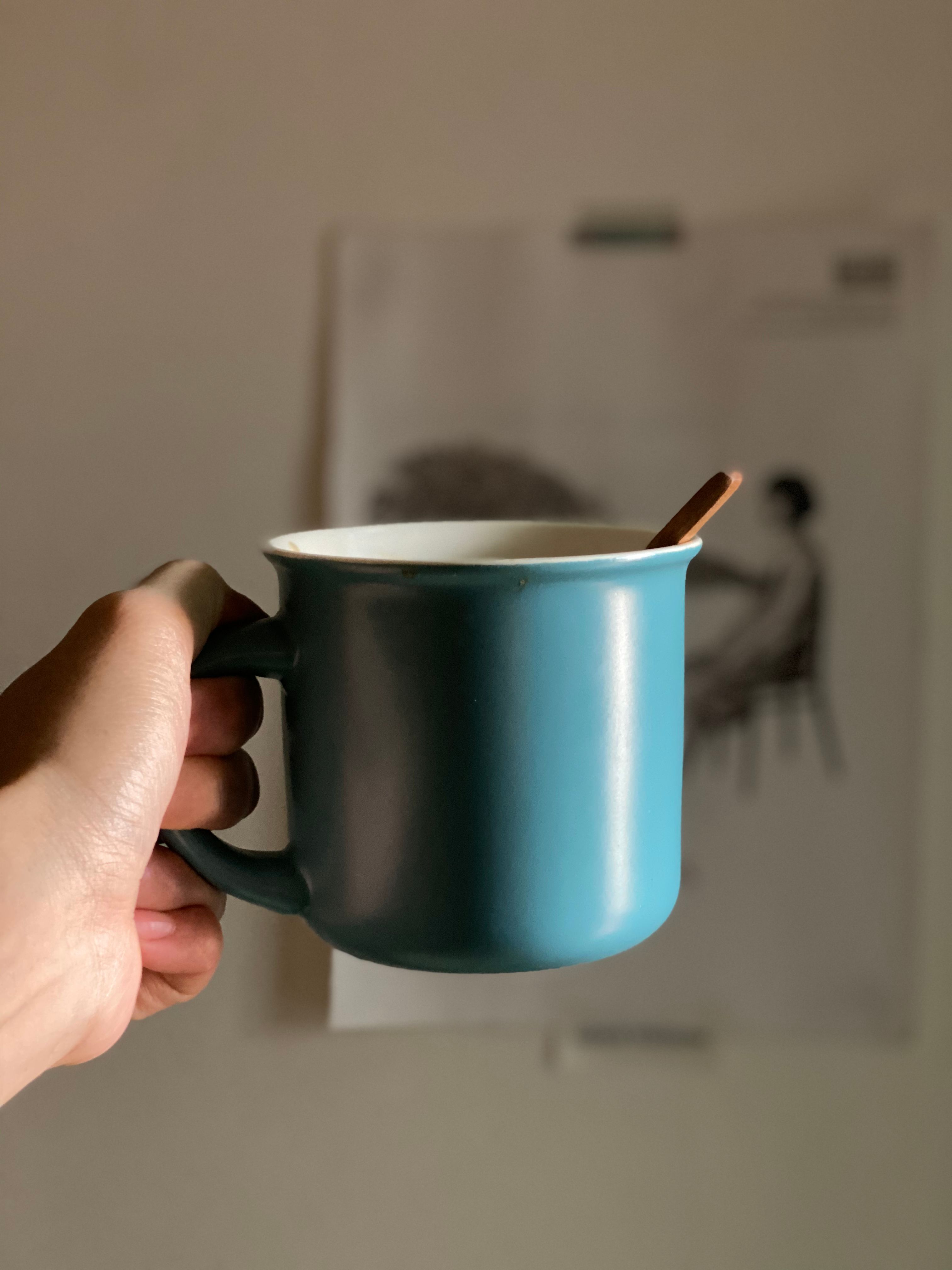 A Hand Holding a White Ceramic Mug · Free Stock Photo