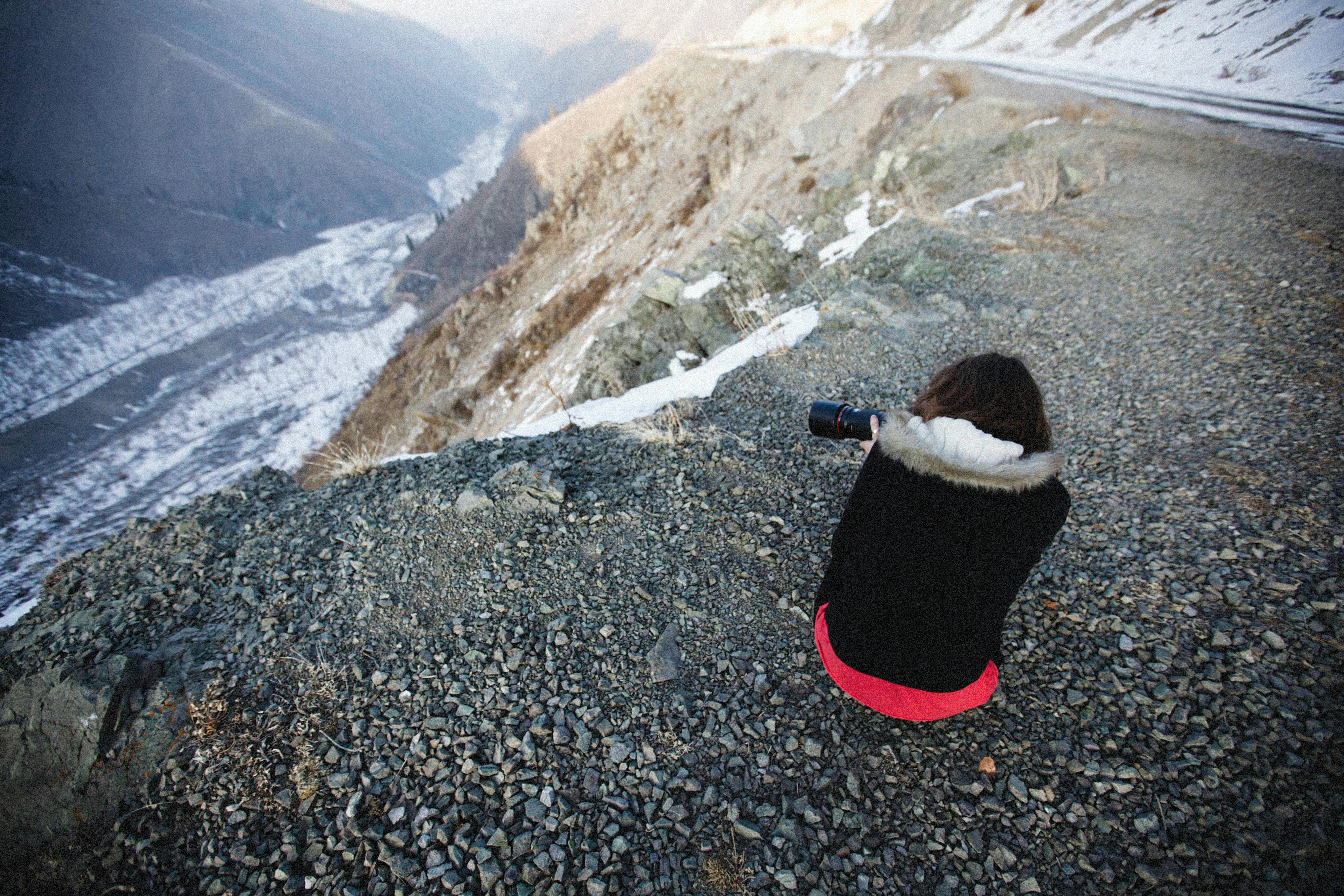 A Woman with a Camera in Mountains · Free Stock Photo