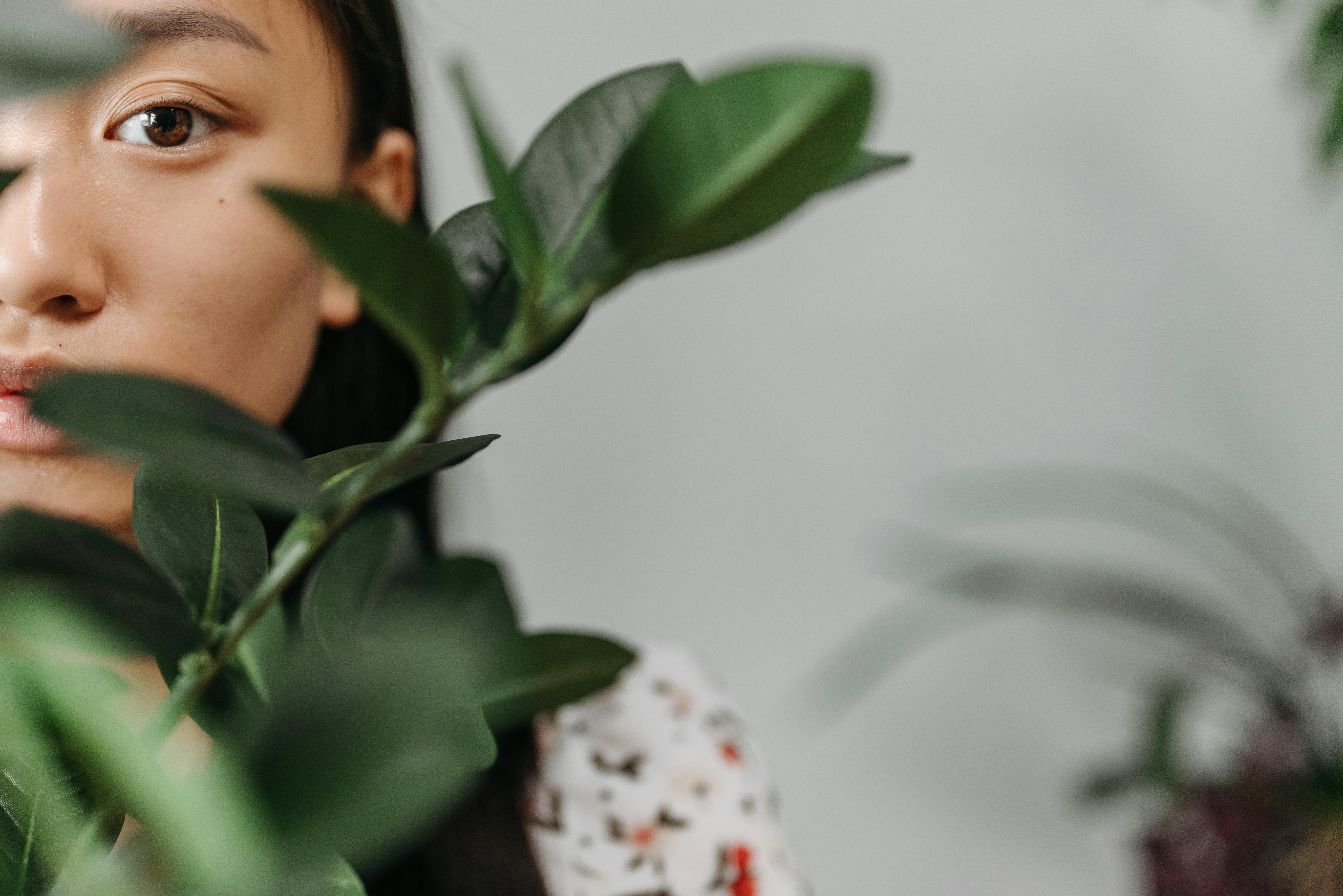 A Woman Behind Leaves of a Plant · Free Stock Photo