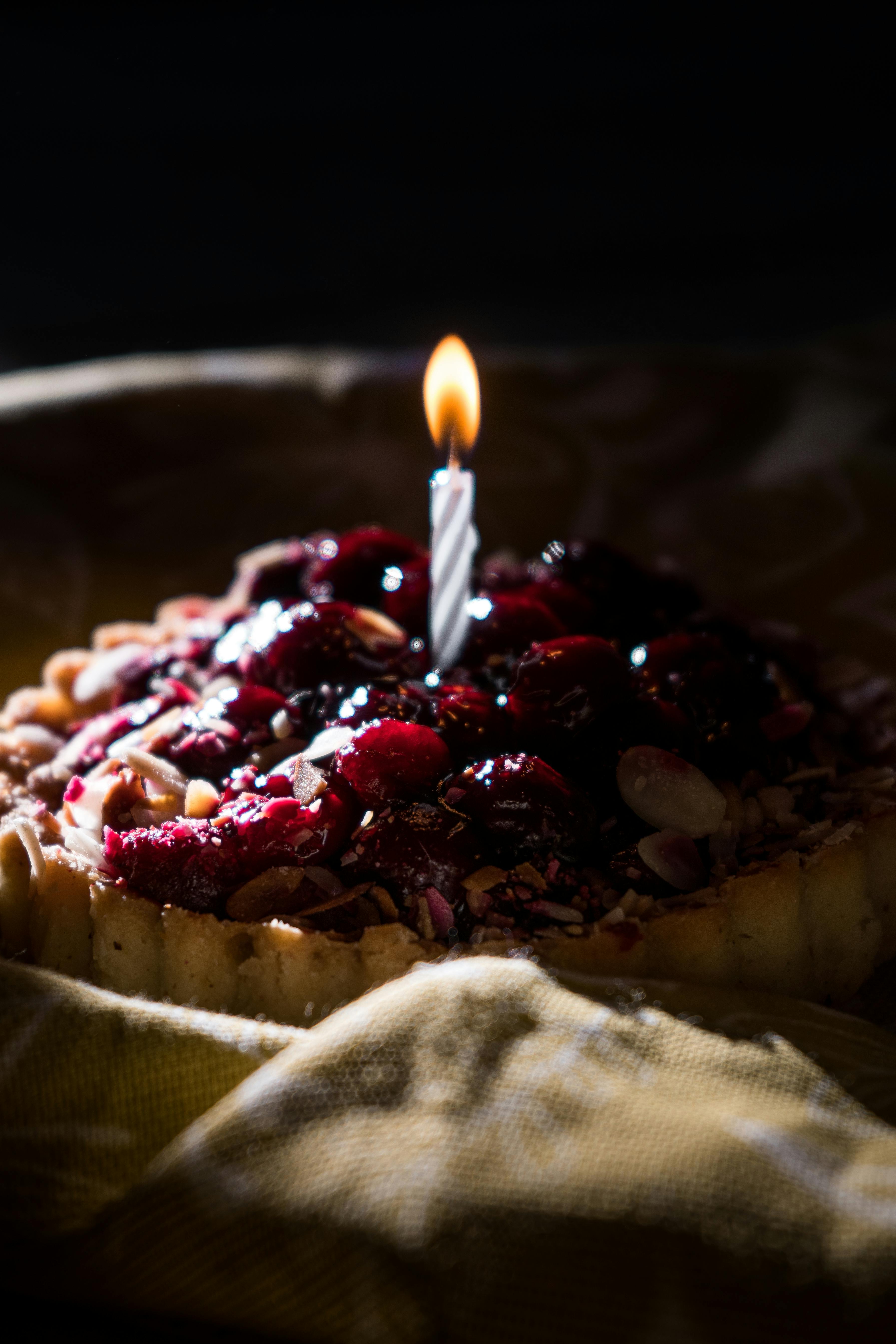 Hand over Candle in Cake · Free Stock Photo