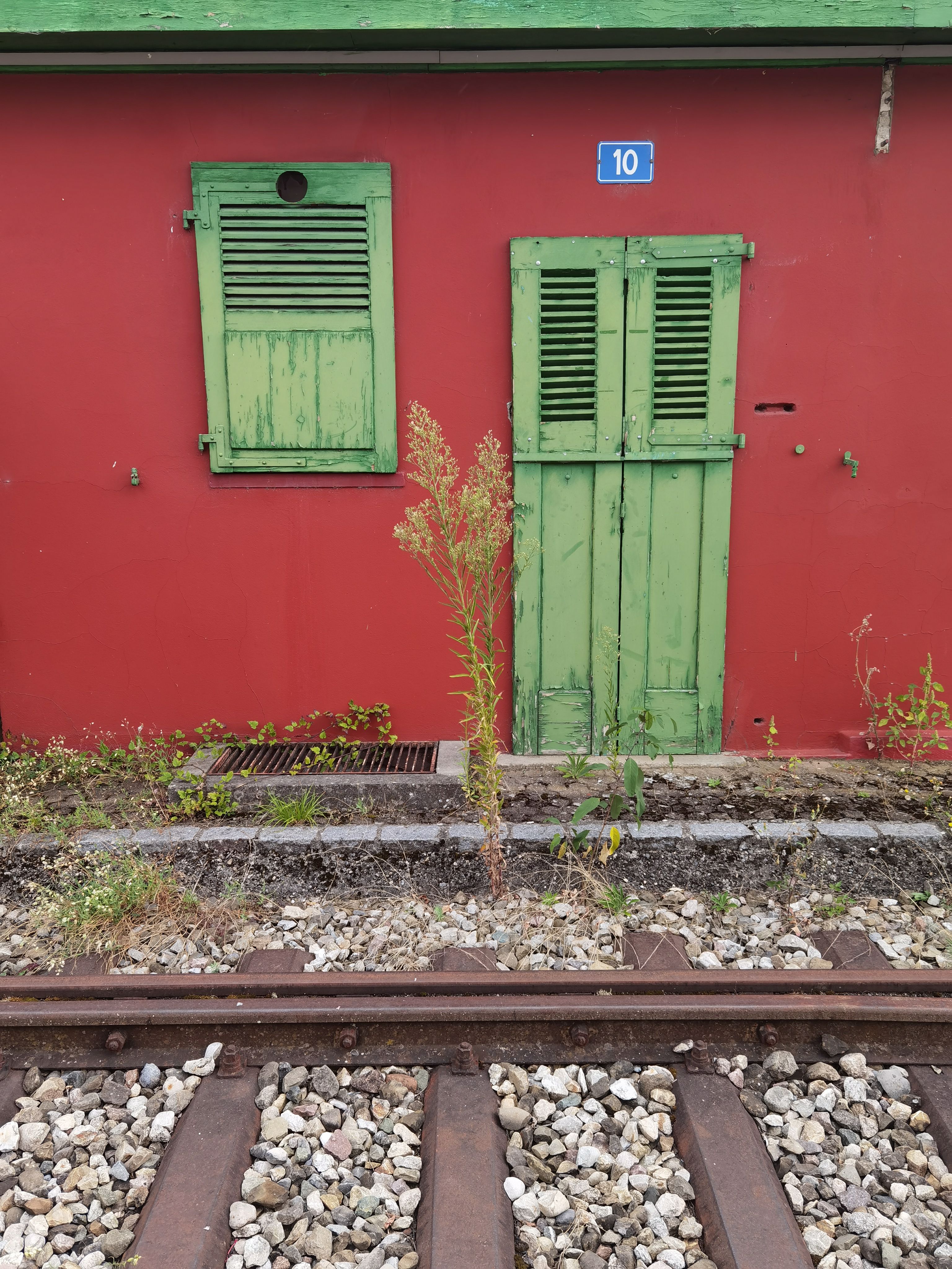 Colorful Building near Railway Tracks · Free Stock Photo