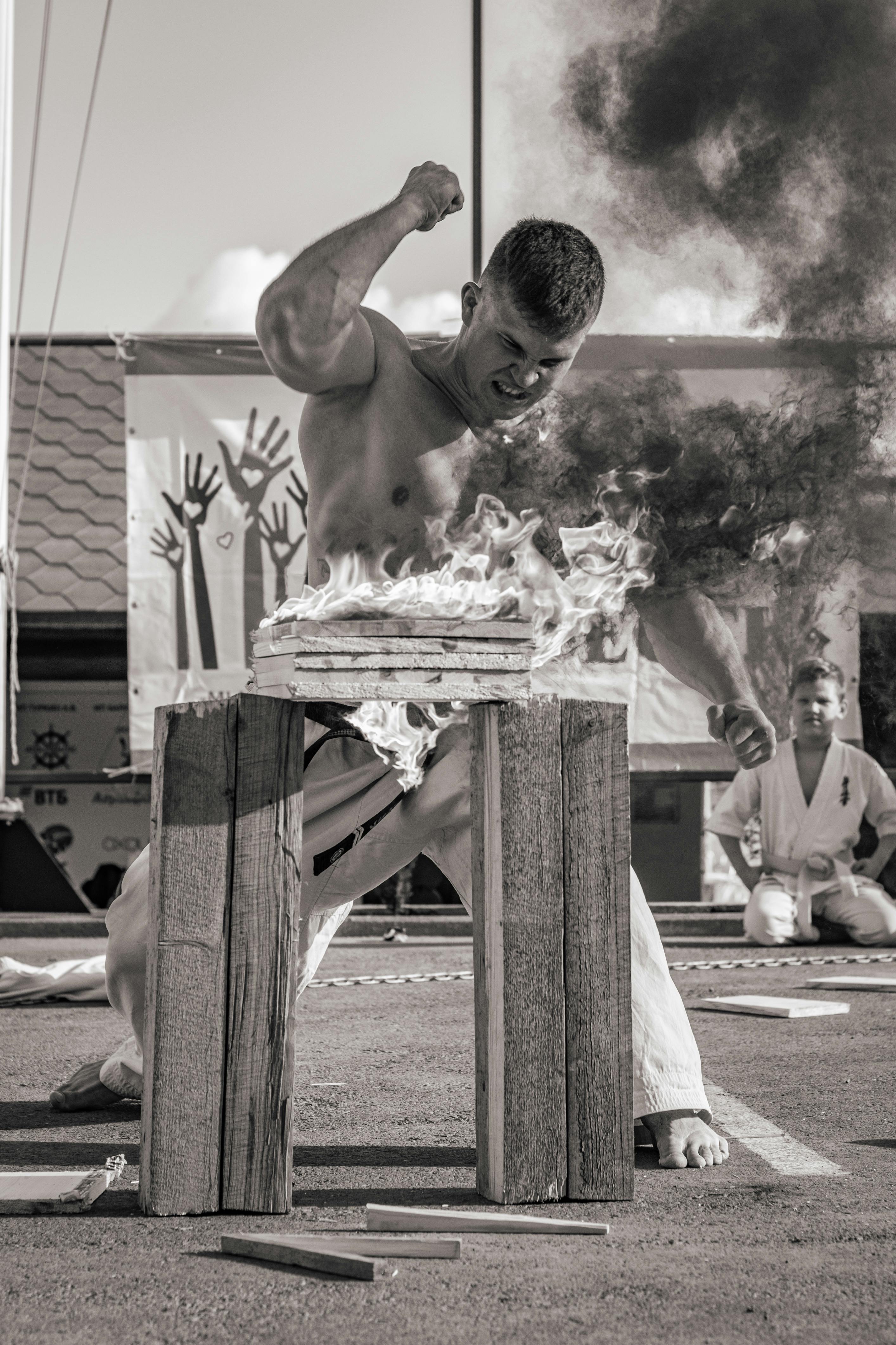 Strongman Breaking Burning Bricks with Hand · Free Stock Photo