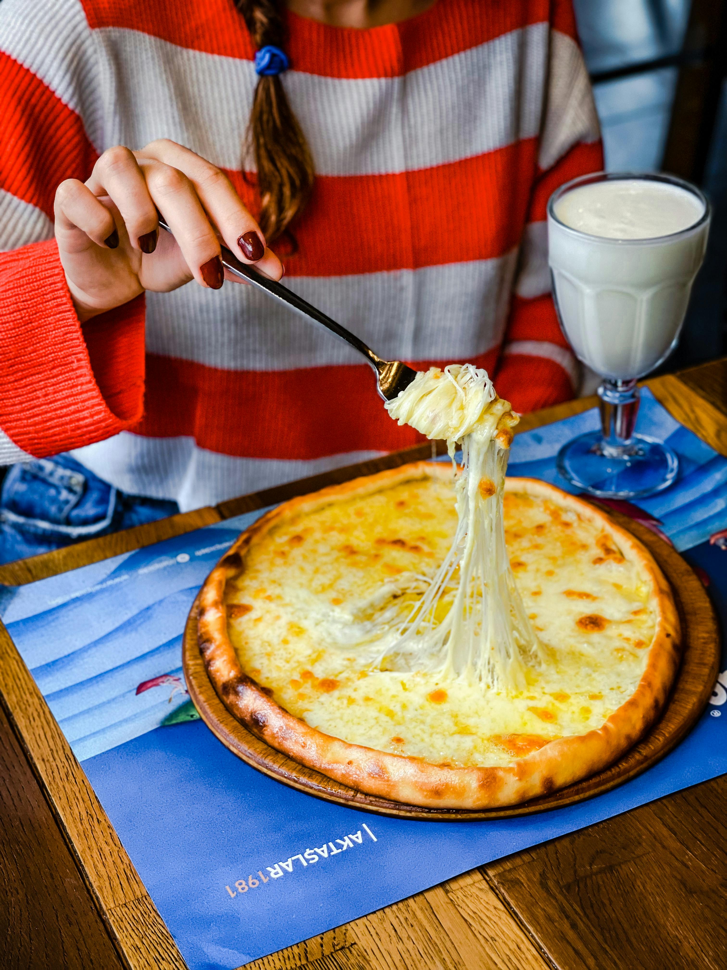Women Sitting on Pavement and Eating Pizza · Free Stock Photo