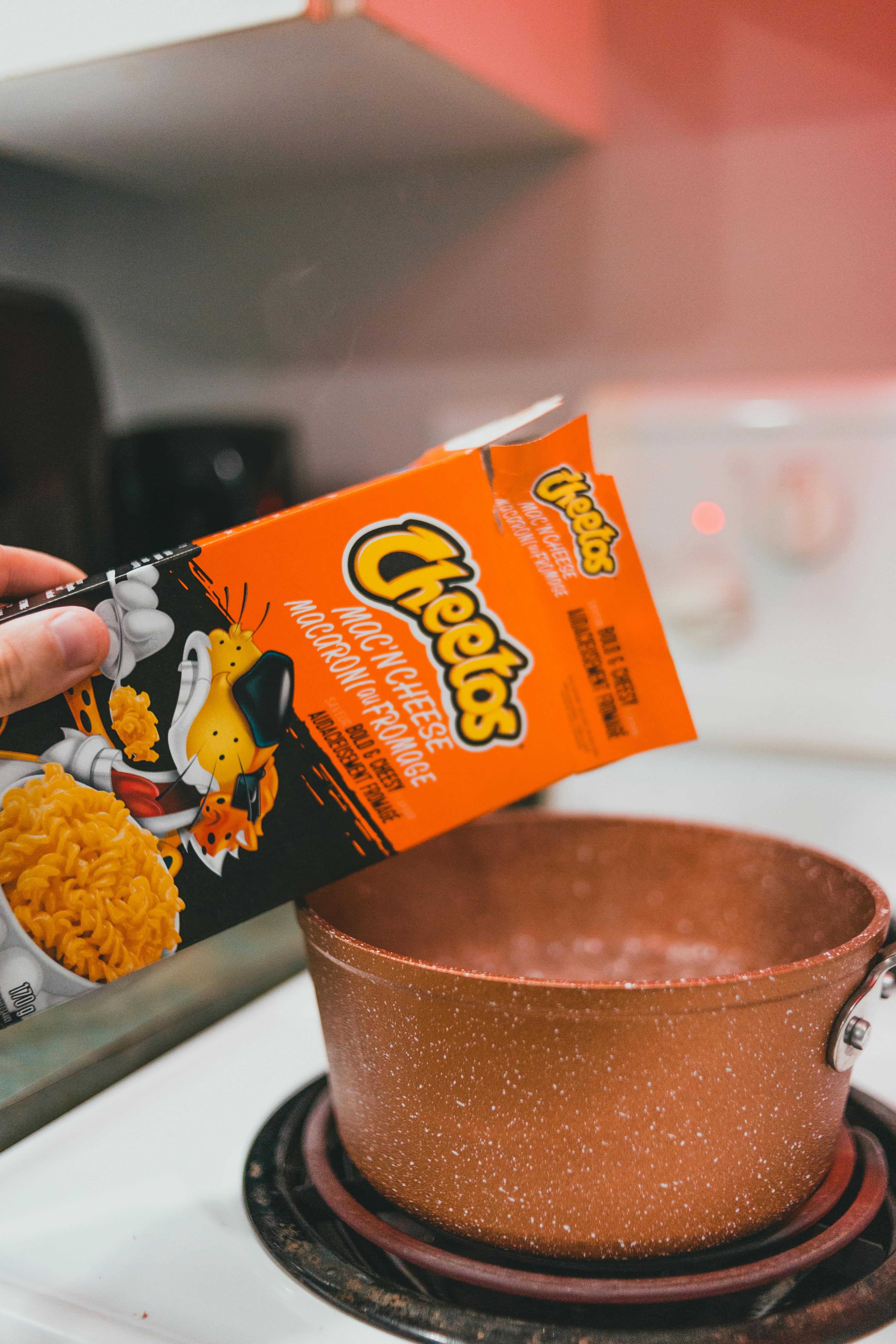 A Person Holding a Box of Cheetos · Free Stock Photo