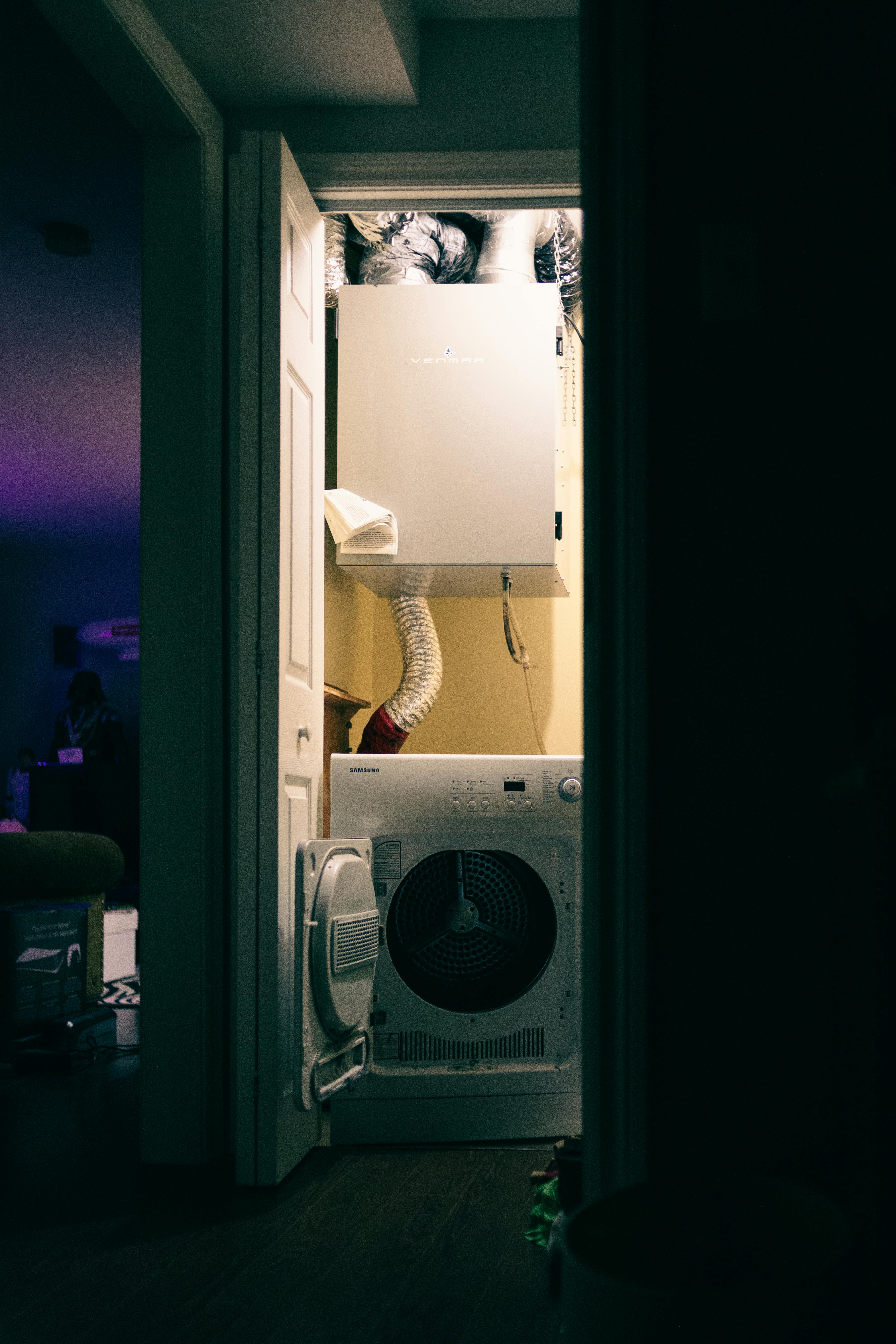 A Person Putting Clothes in a Washing Machine · Free Stock Photo