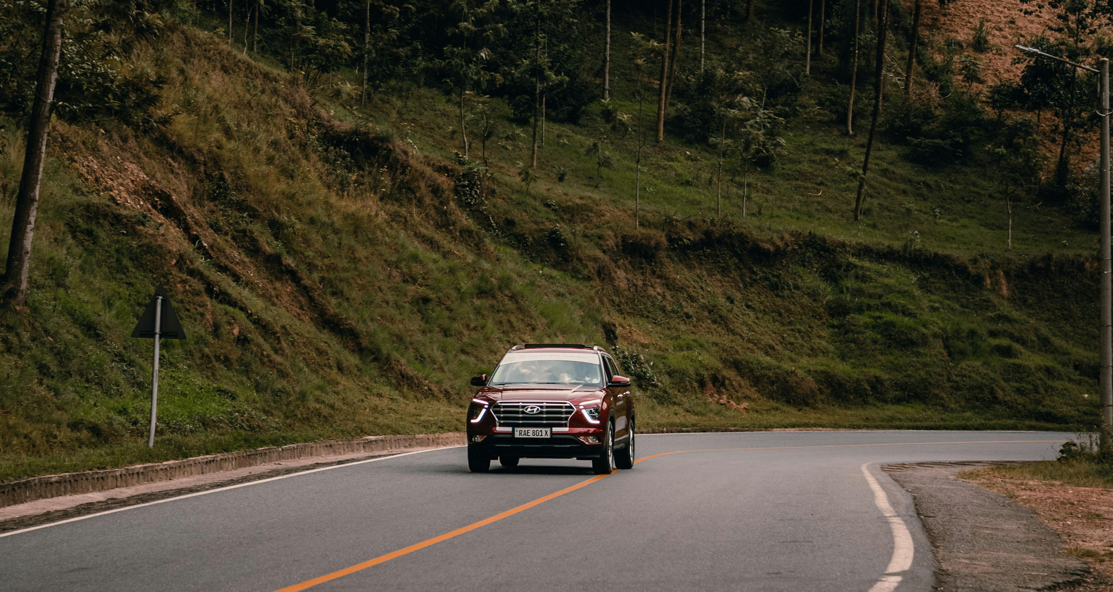 Vintage car riding on road in forest · Free Stock Photo