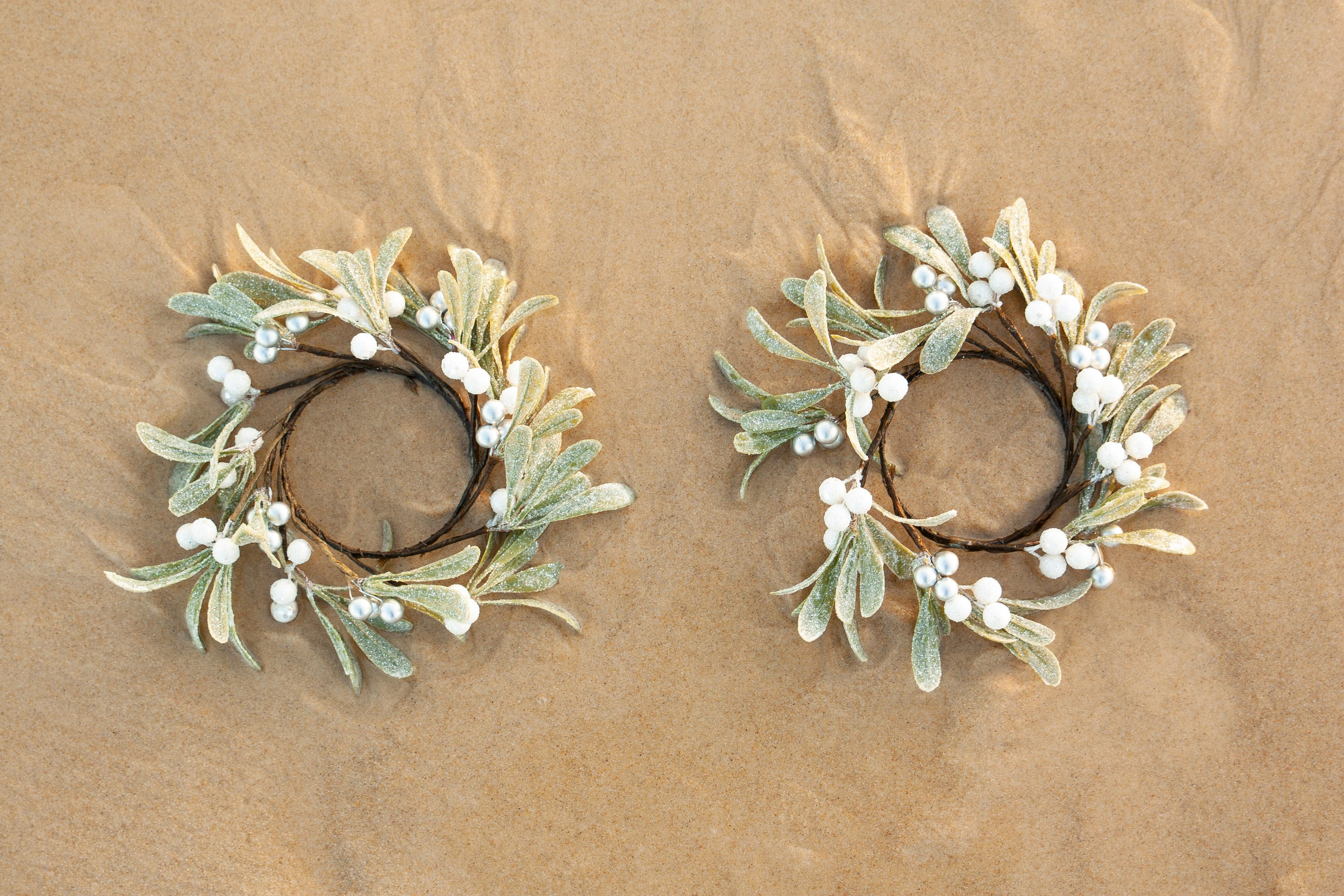 Two Mistletoe Rings on Sand · Free Stock Photo