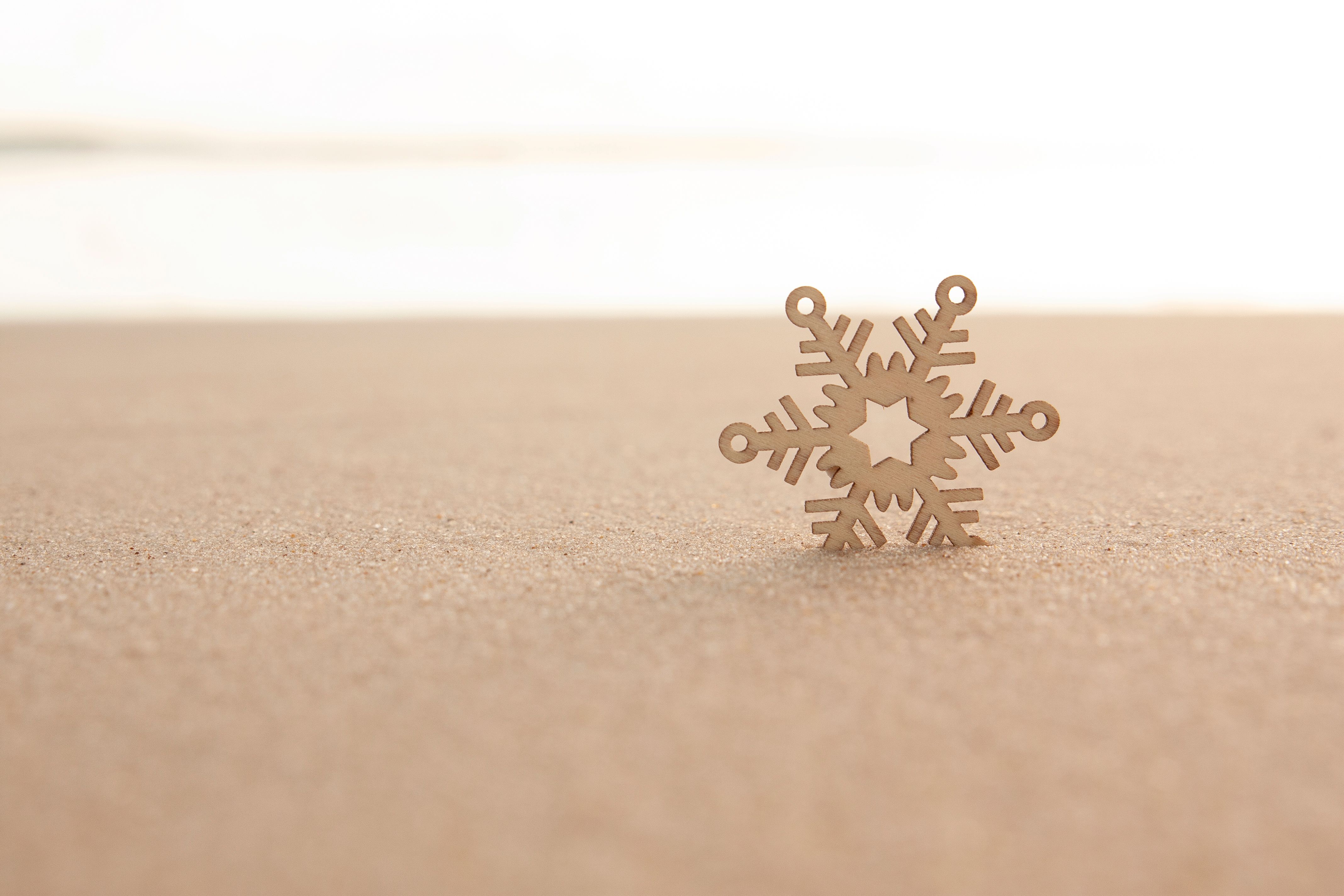 A Brown Snowflake Ornament on Sand · Free Stock Photo