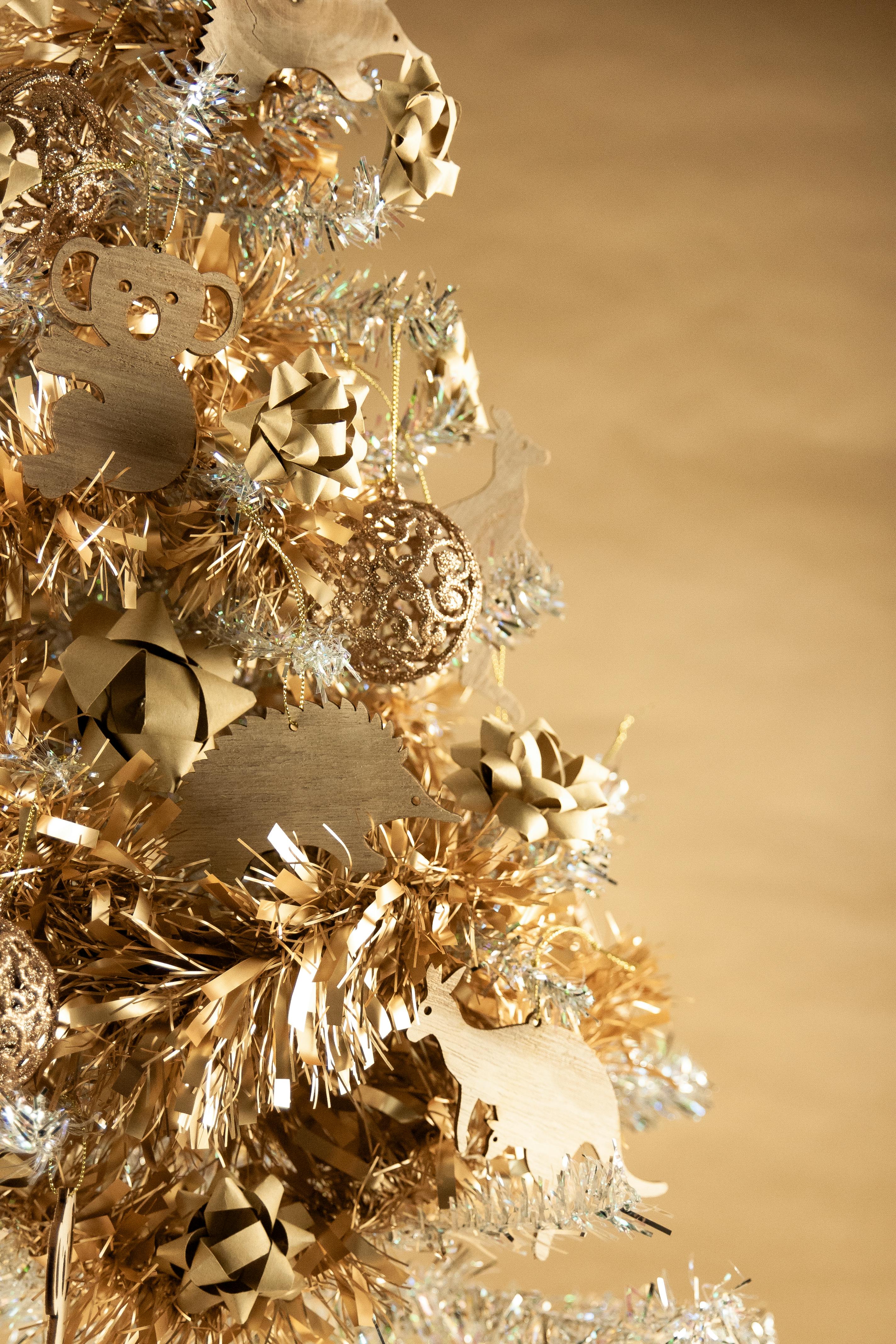 A Silver Christmas Tree with Gold Christmas Ornaments · Free Stock Photo