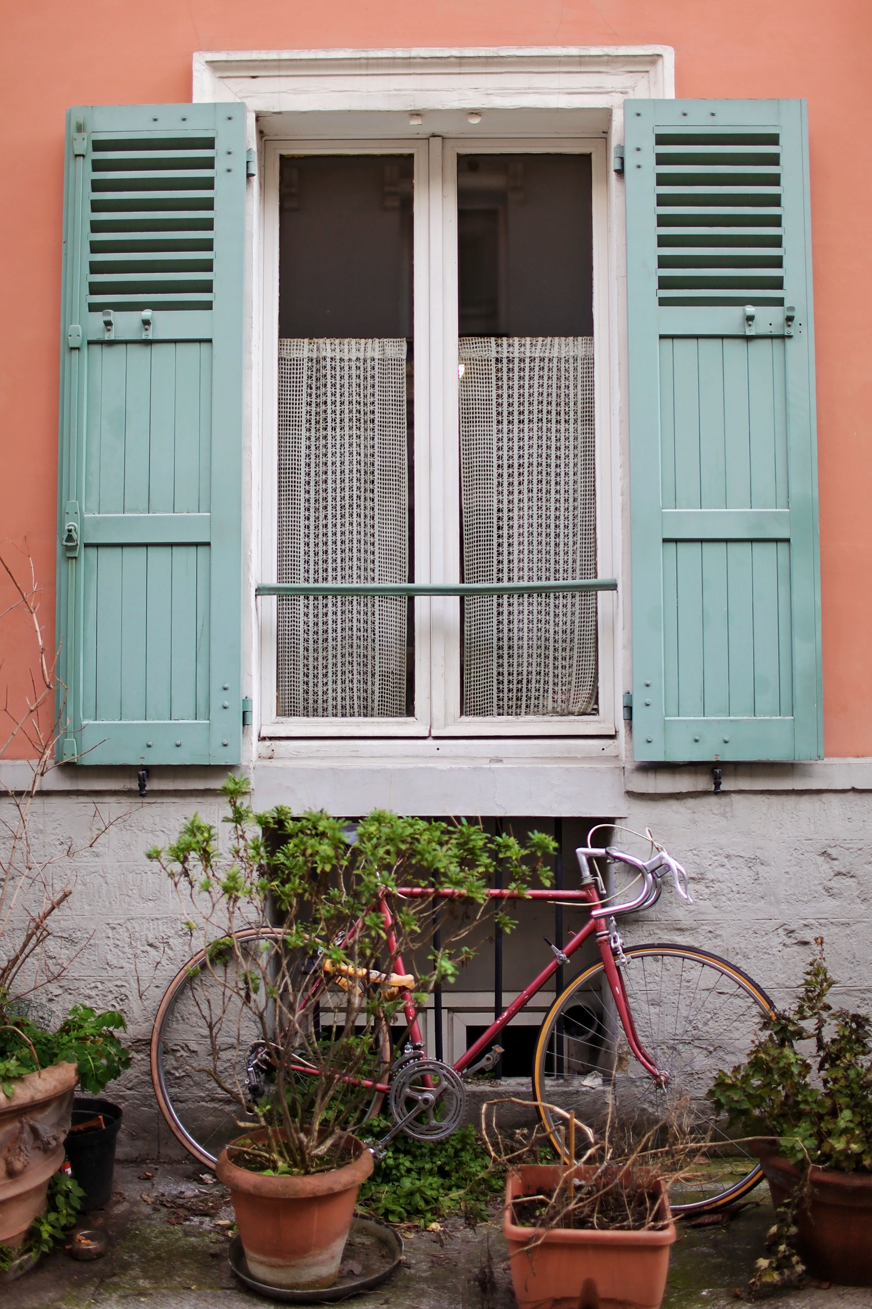 Window with green shutters on peach colored house in Paris · Free Stock ...