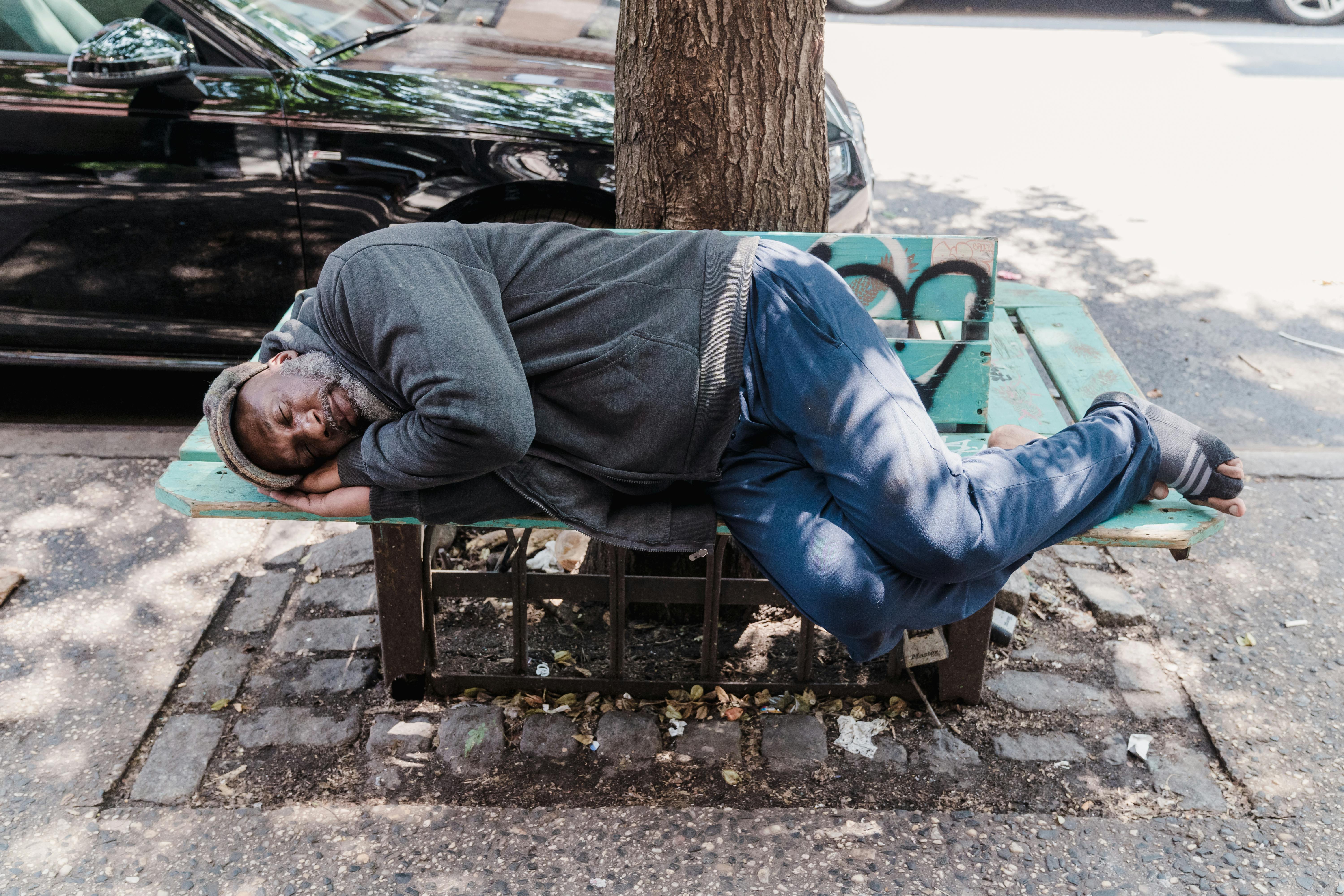 Man Sleeping on a Green Bench · Free Stock Photo