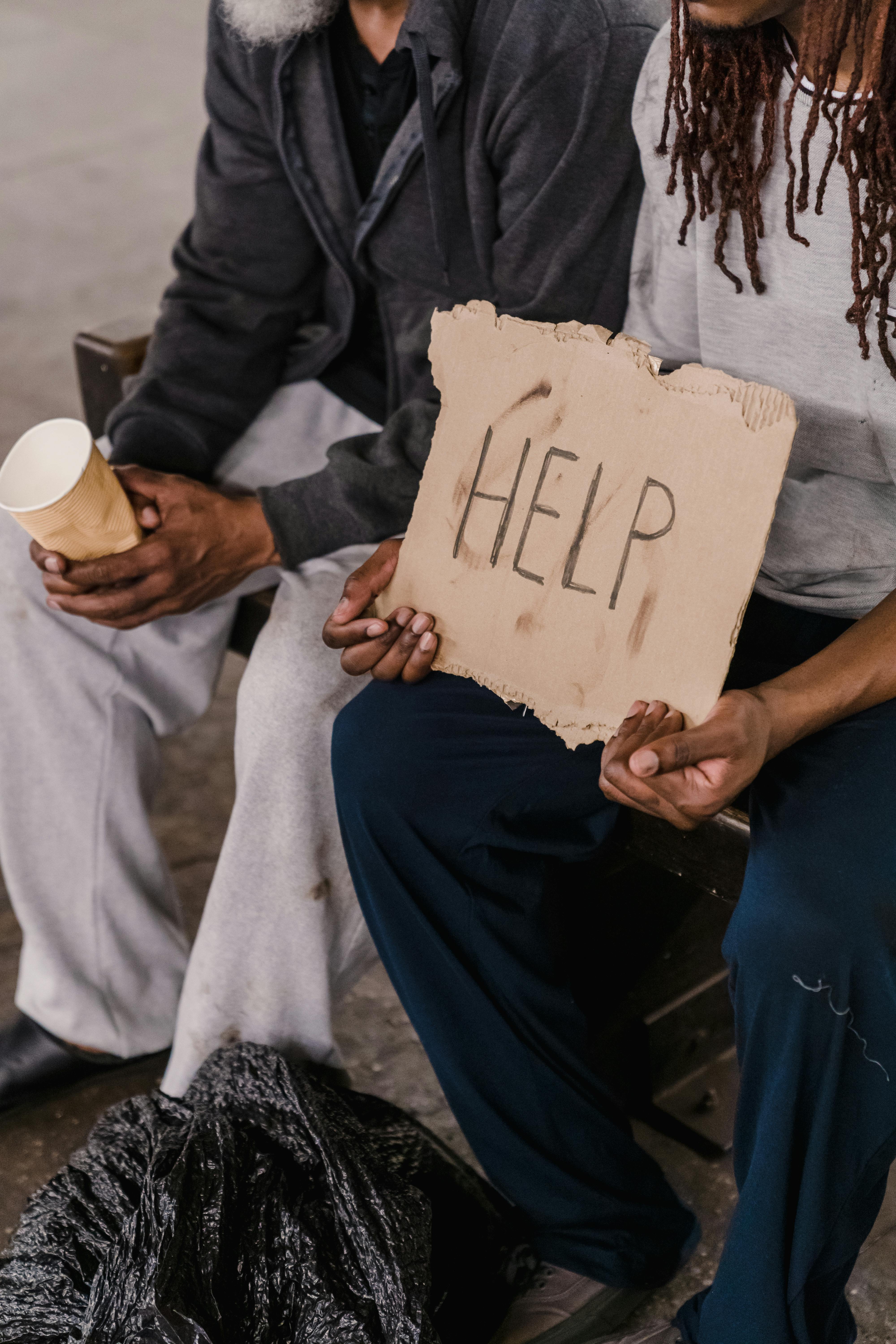 A Person Holding a Stained Cardboard with a Help Sign · Free Stock Photo