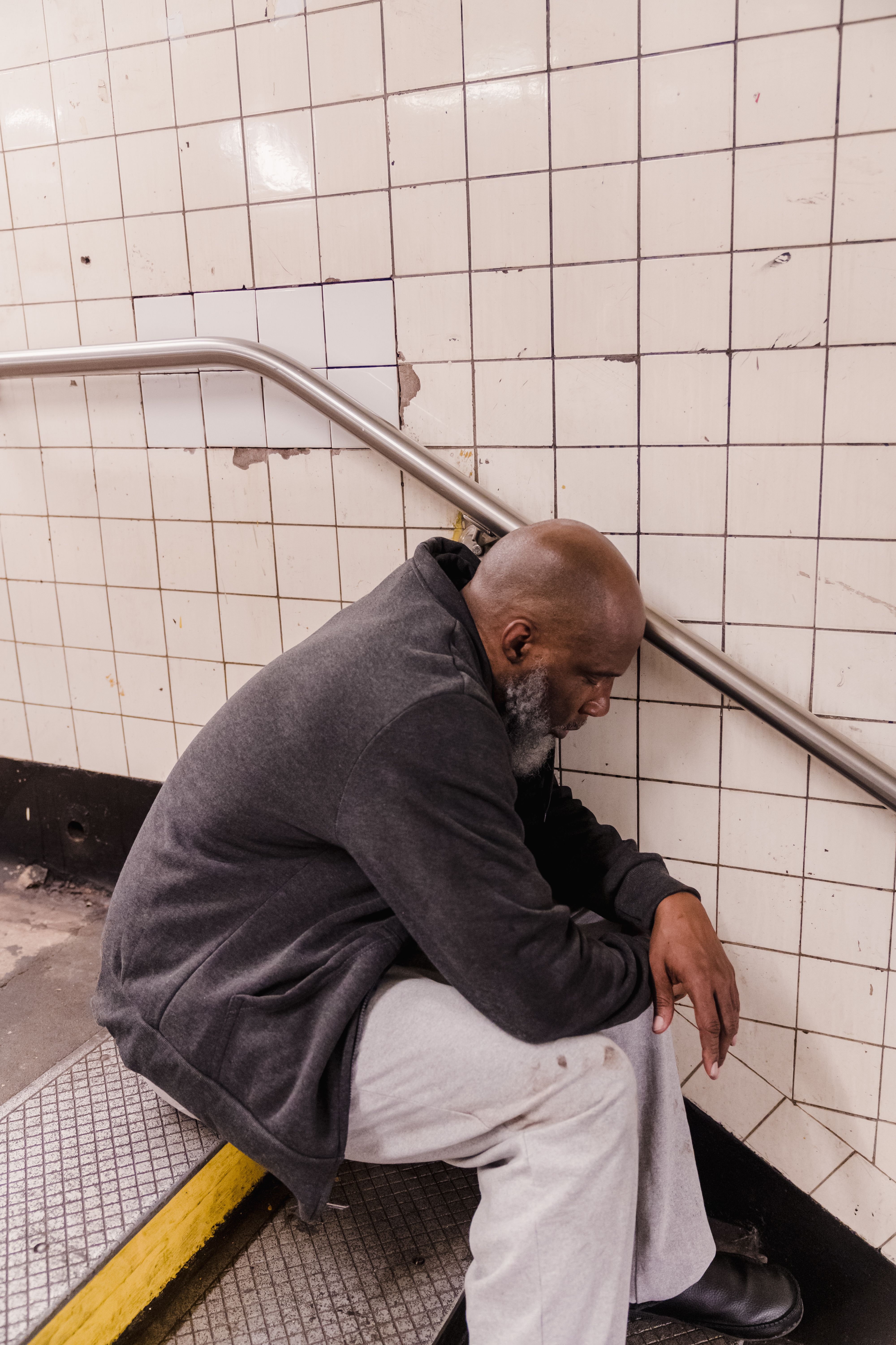Homeless Man Sitting on the Concrete Stairs · Free Stock Photo
