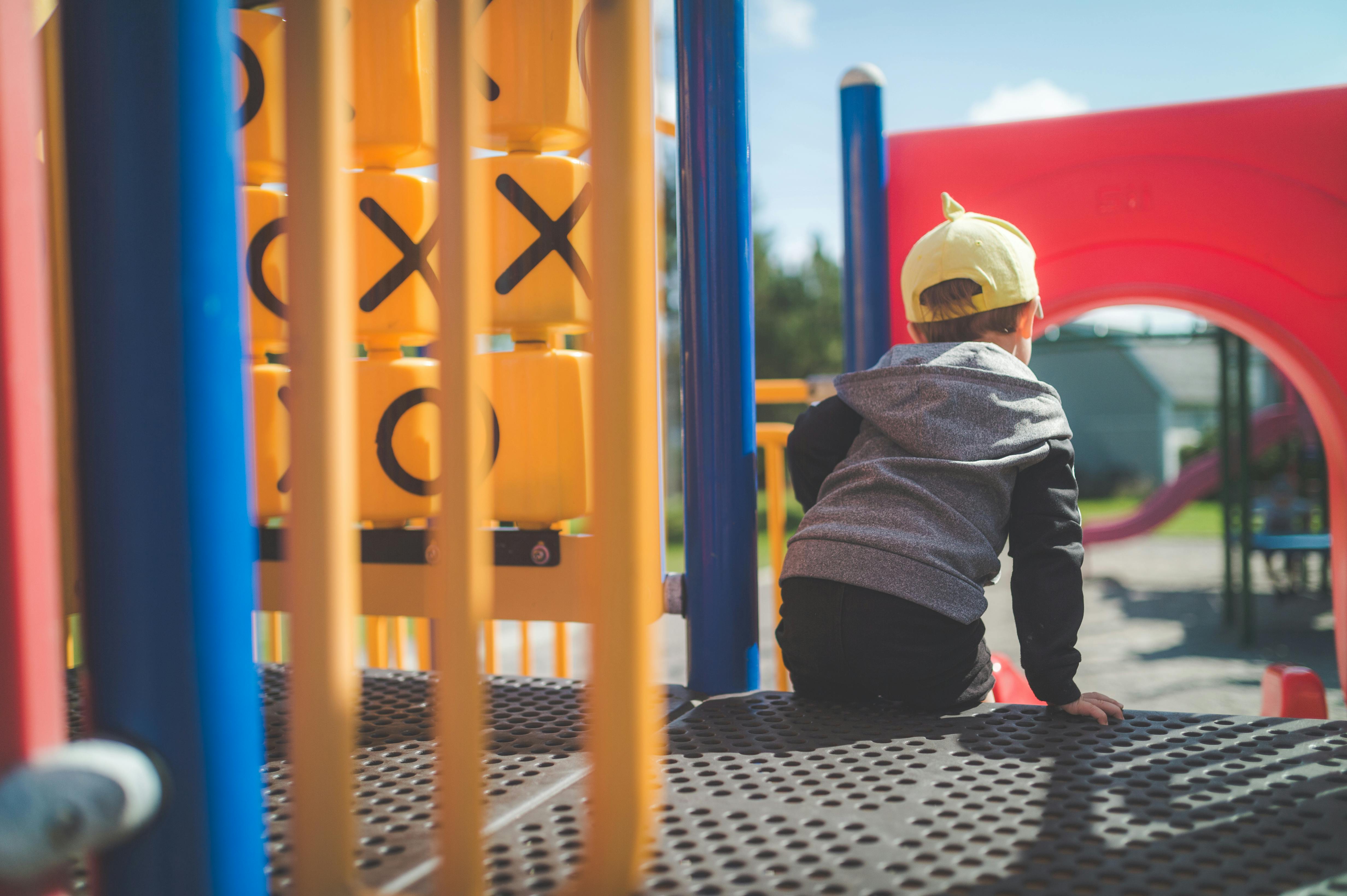 Back View of a Child Playing on a Play Set · Free Stock Photo
