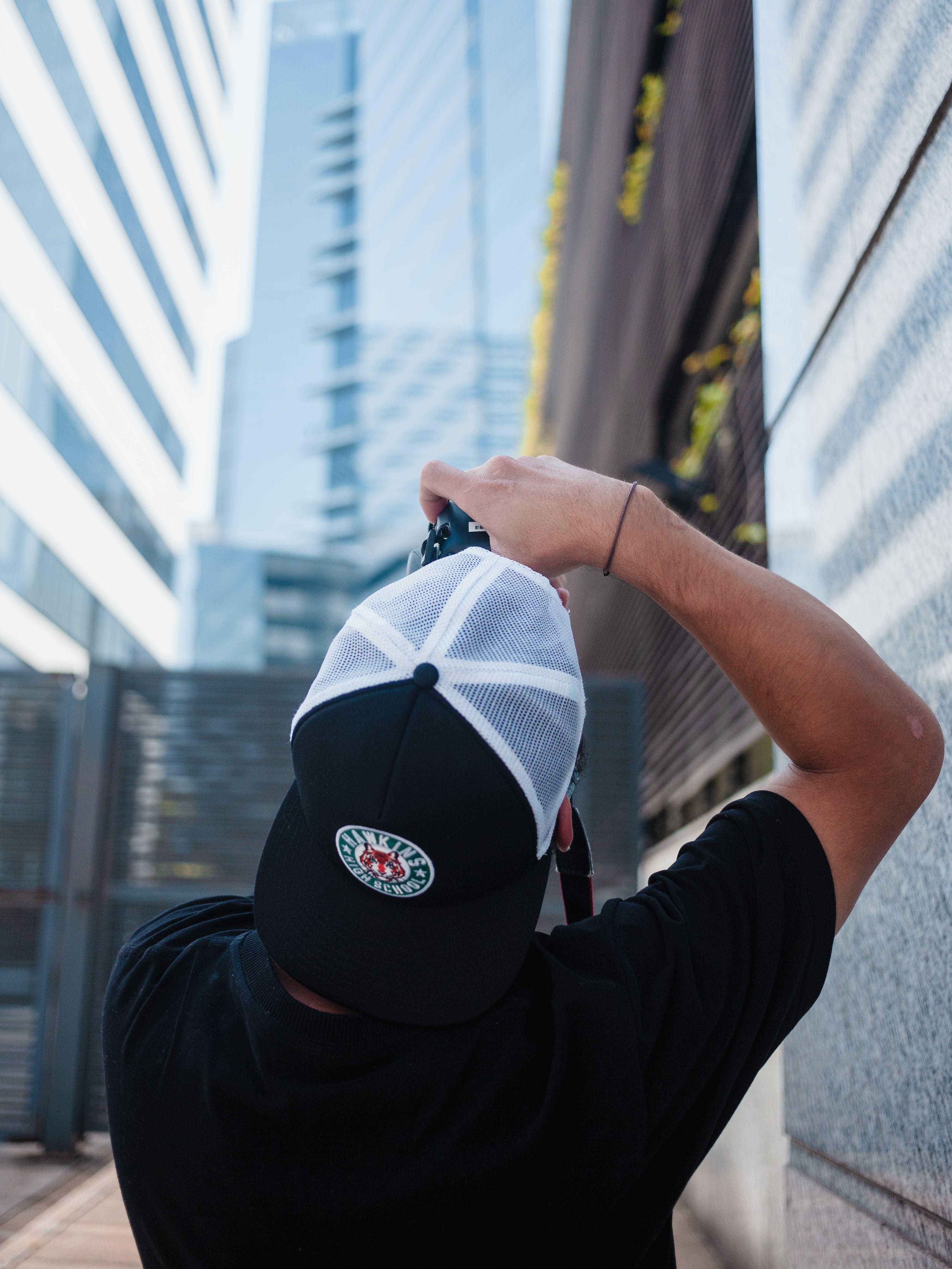 A Man Taking Off his Coat Near a Glass Door · Free Stock Photo
