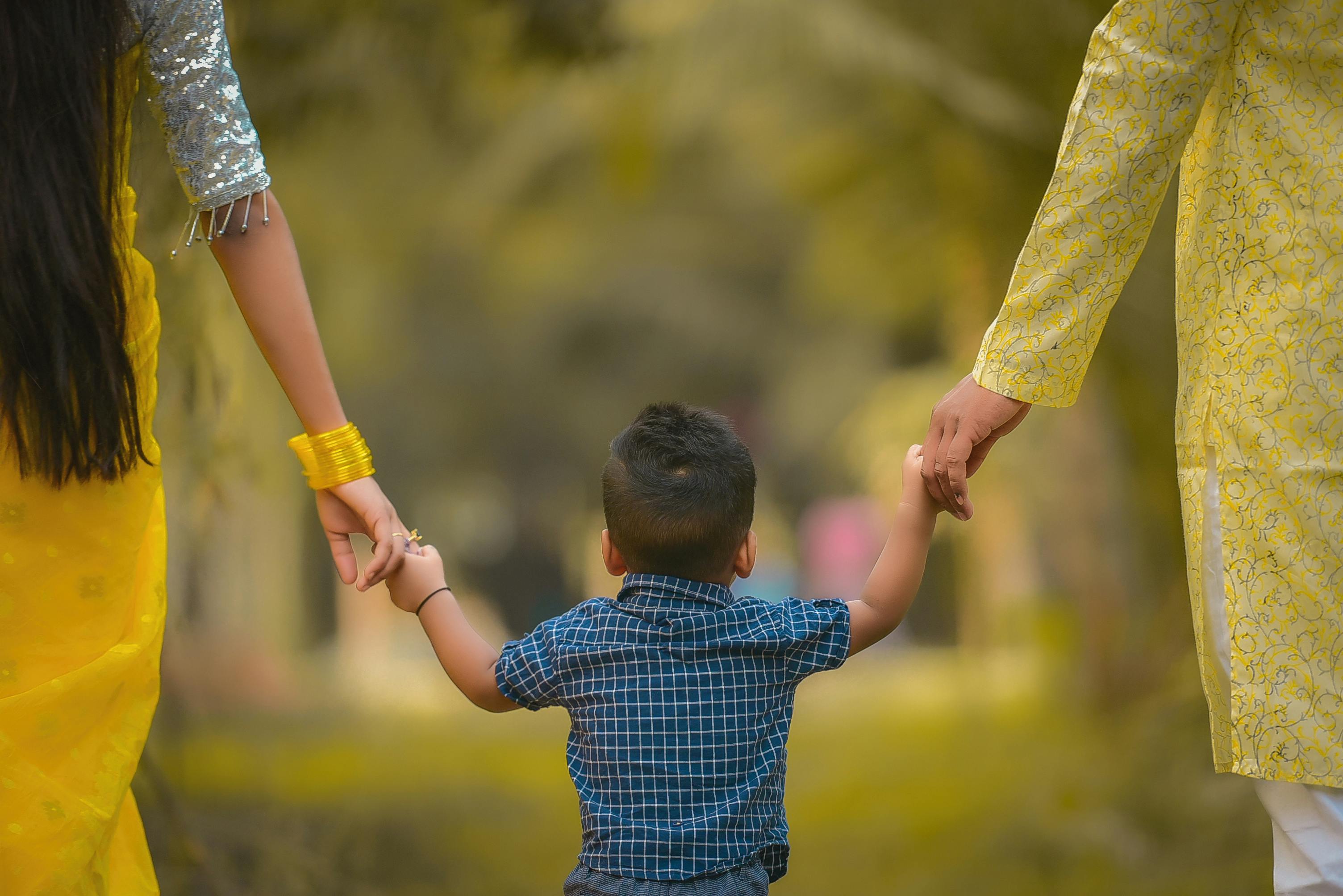 Back View of a Little Boy with His Parents · Free Stock Photo